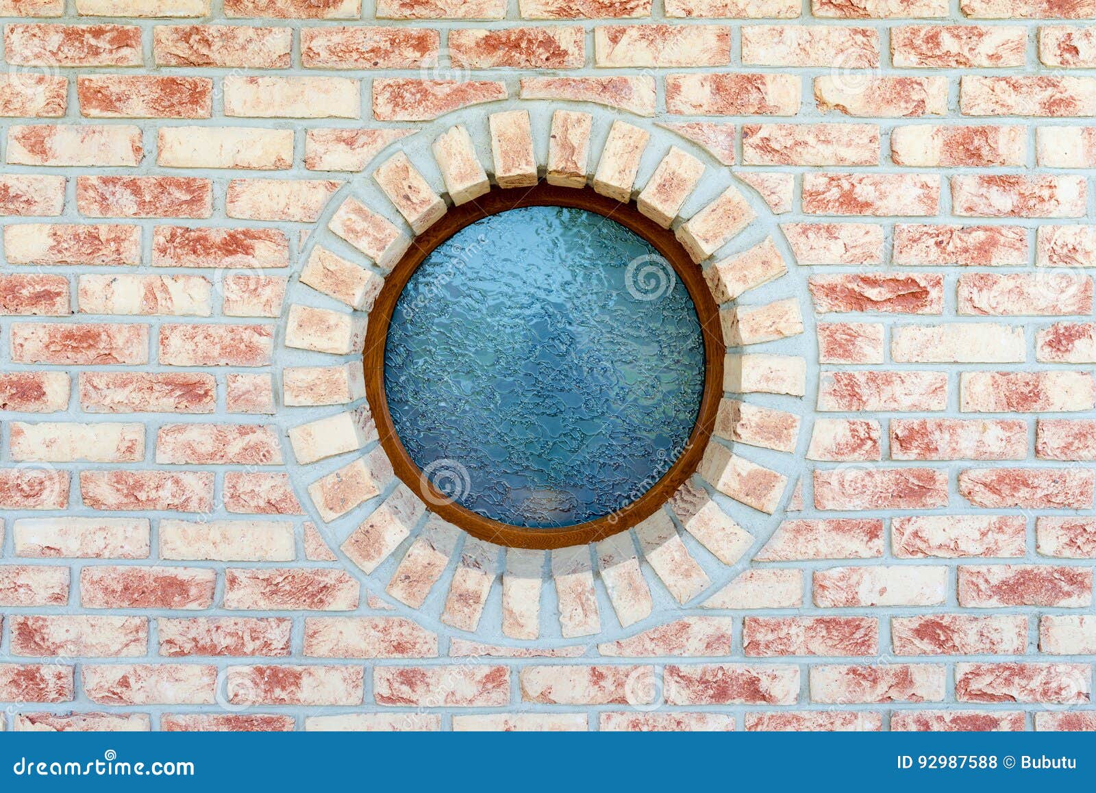 Round window on brick wall stock photo. Image of house - 92987588