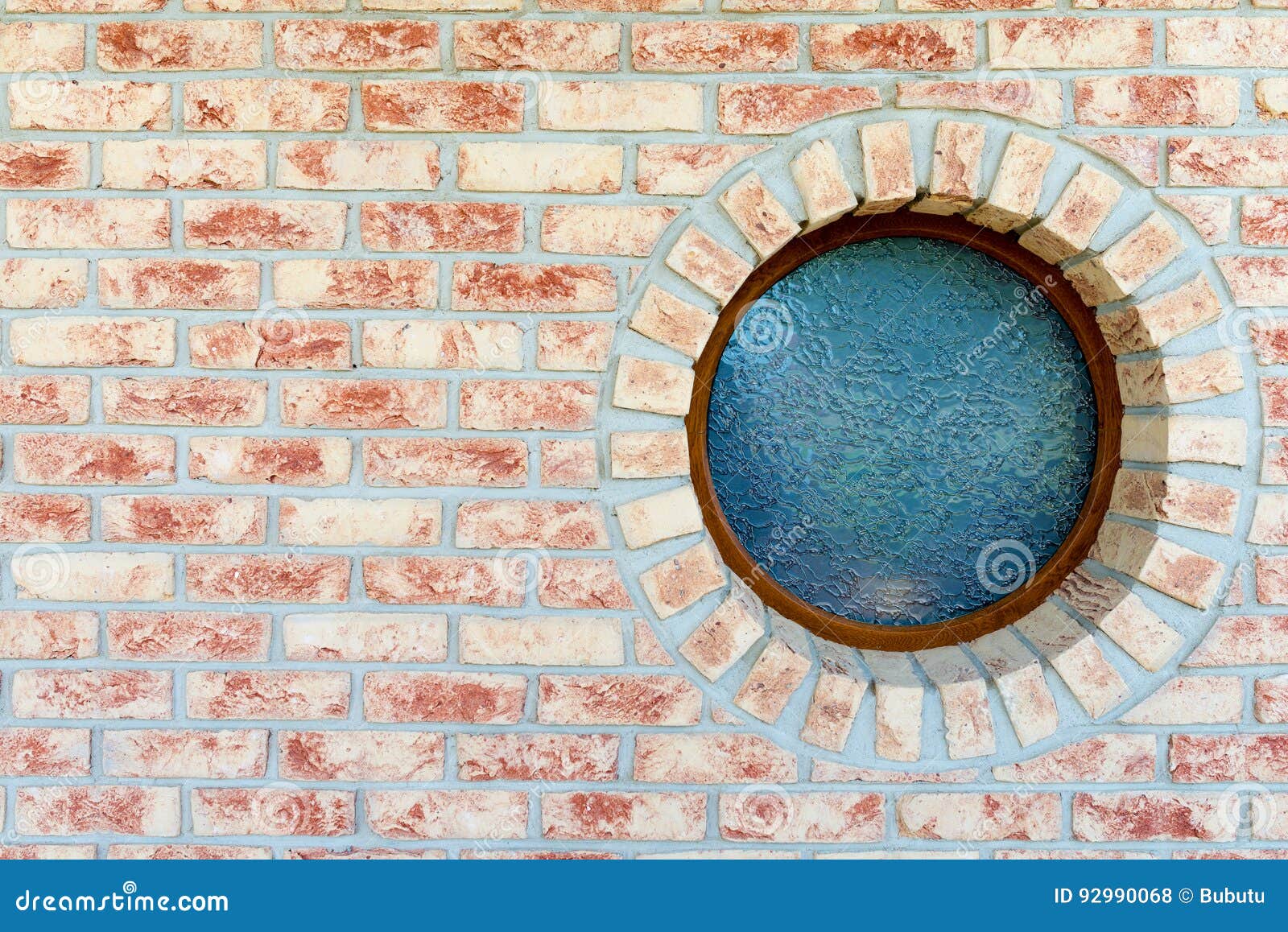 Round window on brick wall stock photo. Image of orange - 92990068