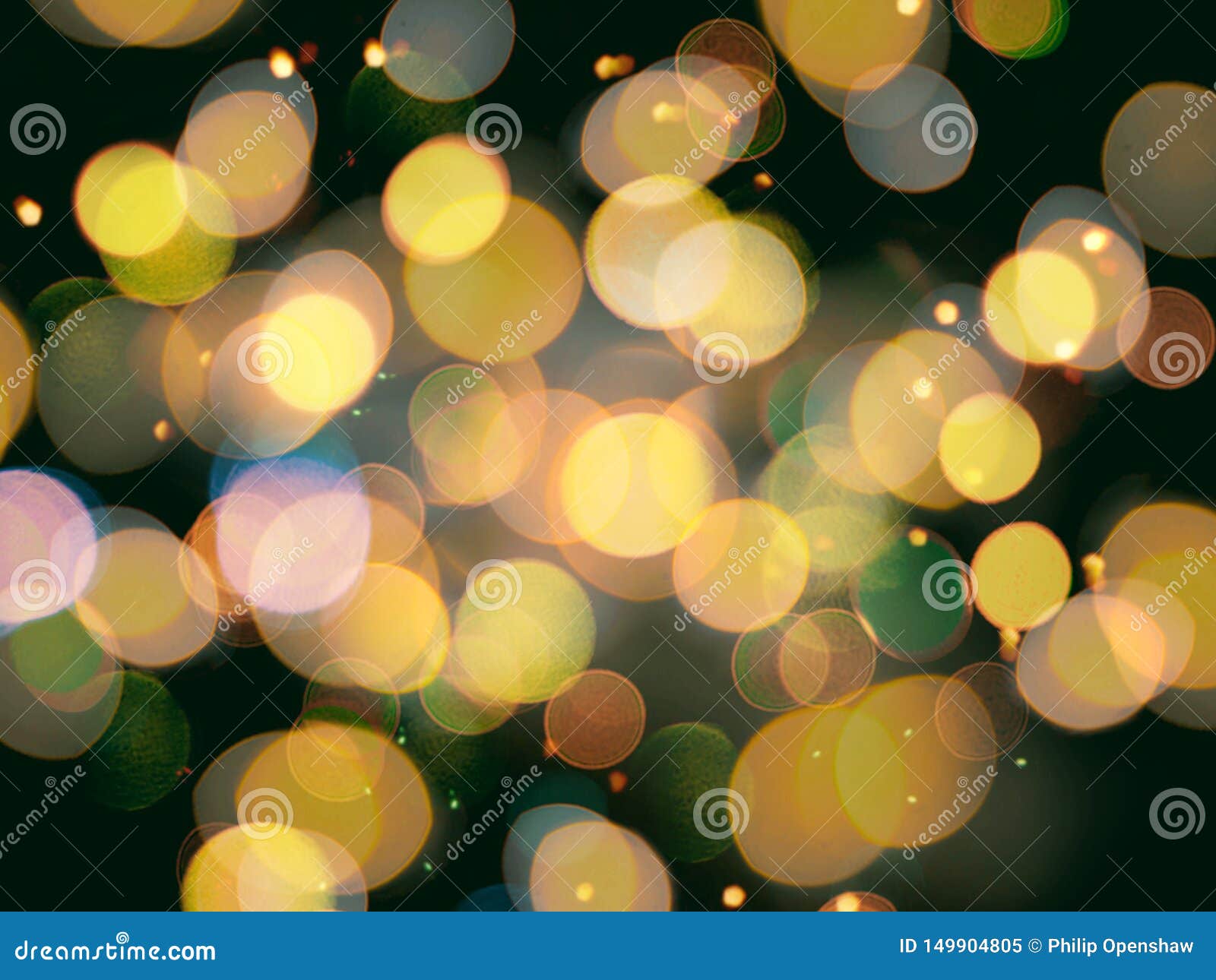 A Round Yellow Coloured Blurred Lights with Sparkles on a Black ...