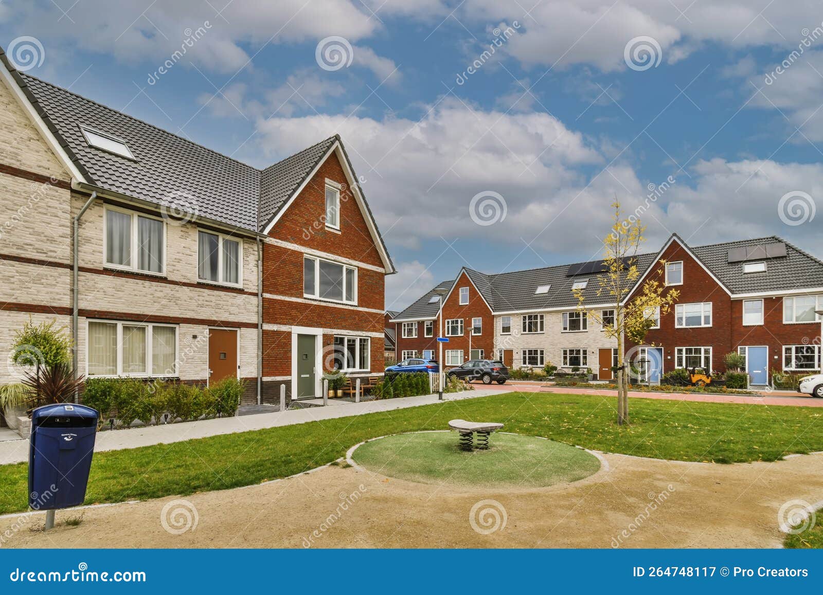 A Roundabout in Front of a Group of Houses Stock Image - Image of ...
