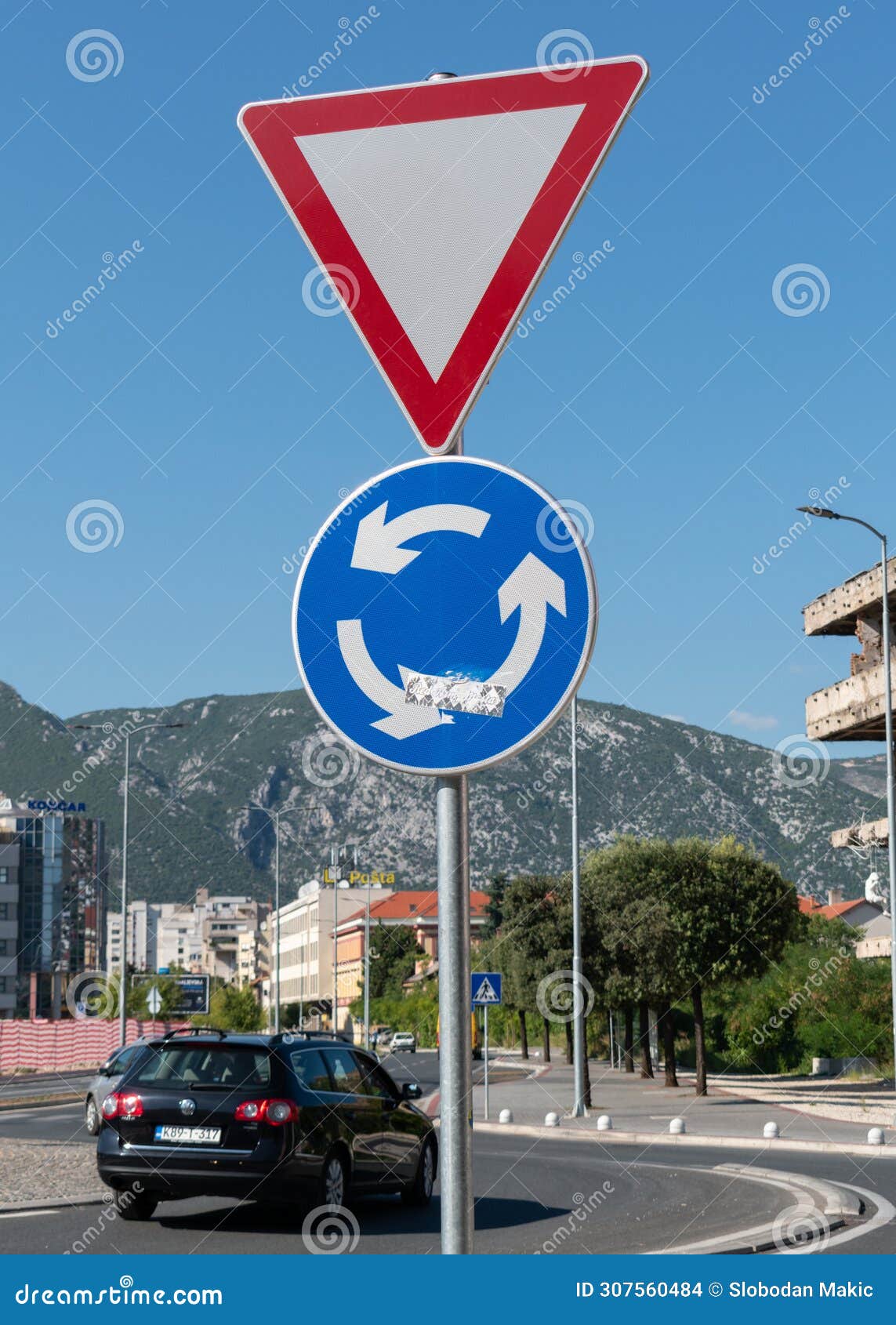 Roundabout or Rotary Sign Below Give Way or Yield Sign Editorial Stock ...