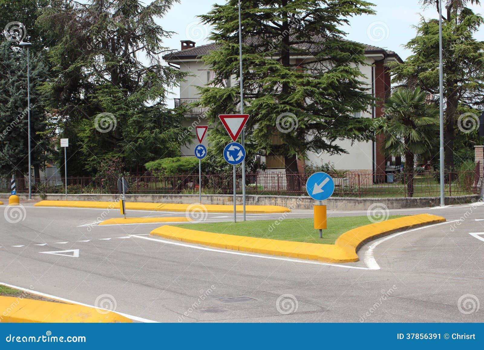 Roundabout with Yellow Curb and Green Grass in Summer Stock Image ...