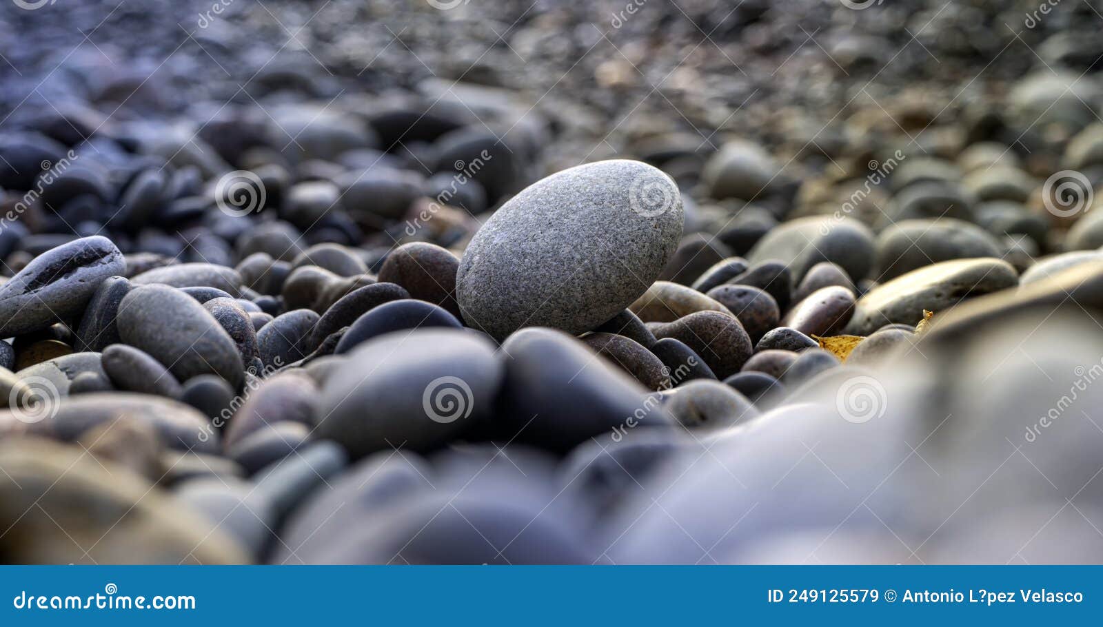 Rounded Boulders of Different Sizes and Colors on a Beach Stock Image ...