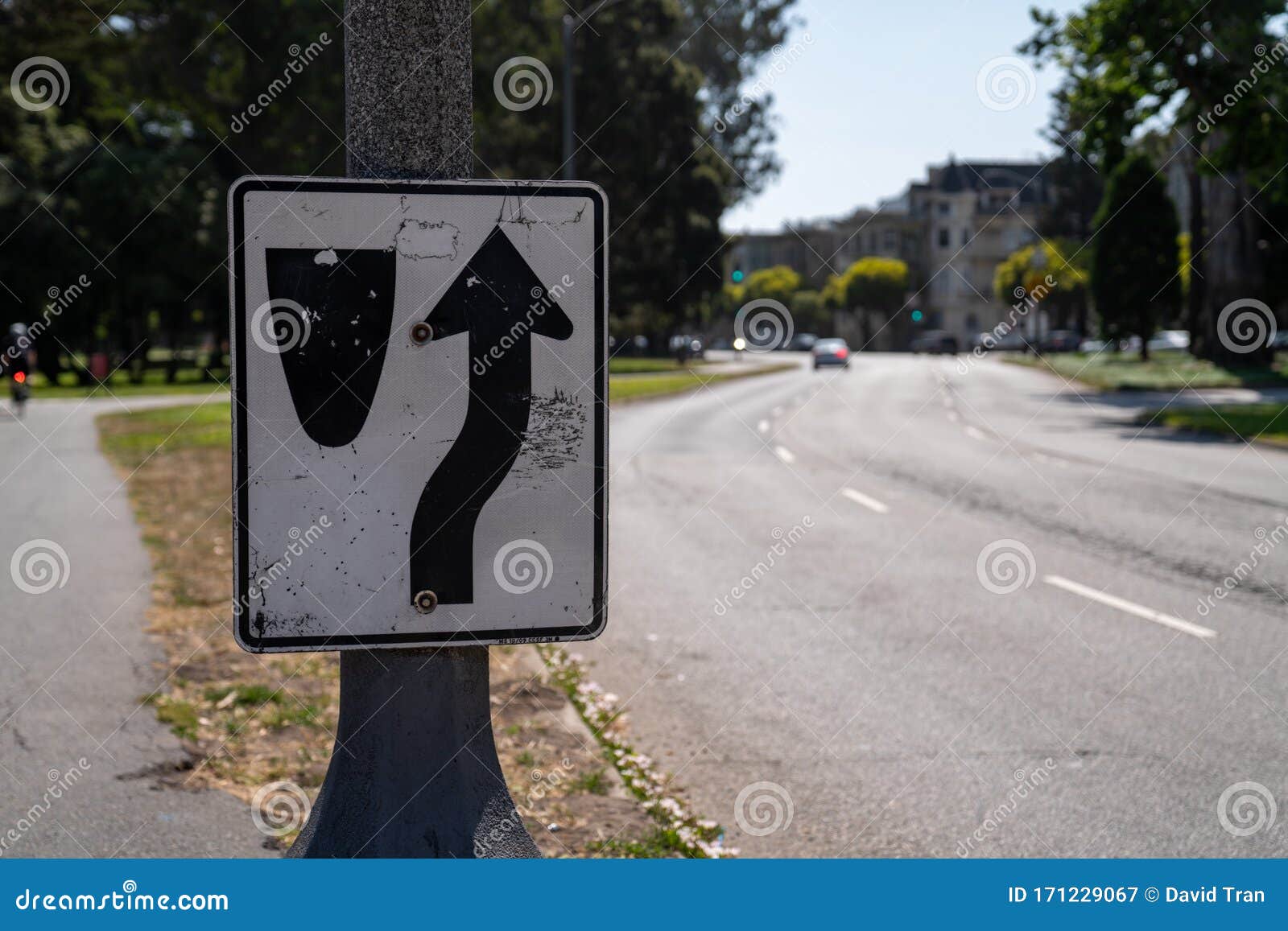 Rounded Curve Corner Warning Sign on Light Post at City Street Stock ...
