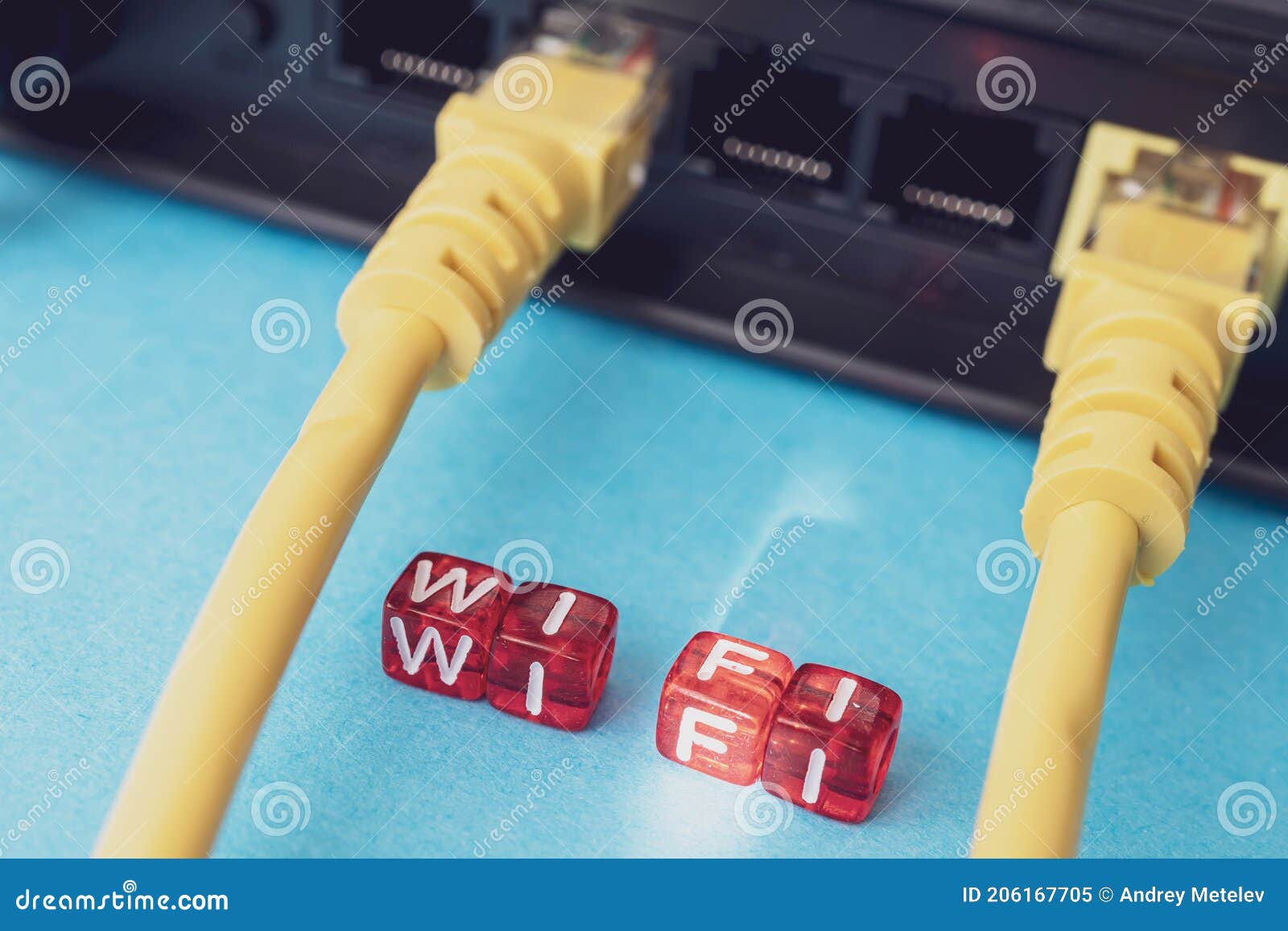 A Router with Yellow Patch Cords Inserted into it and Cubes on Top of ...