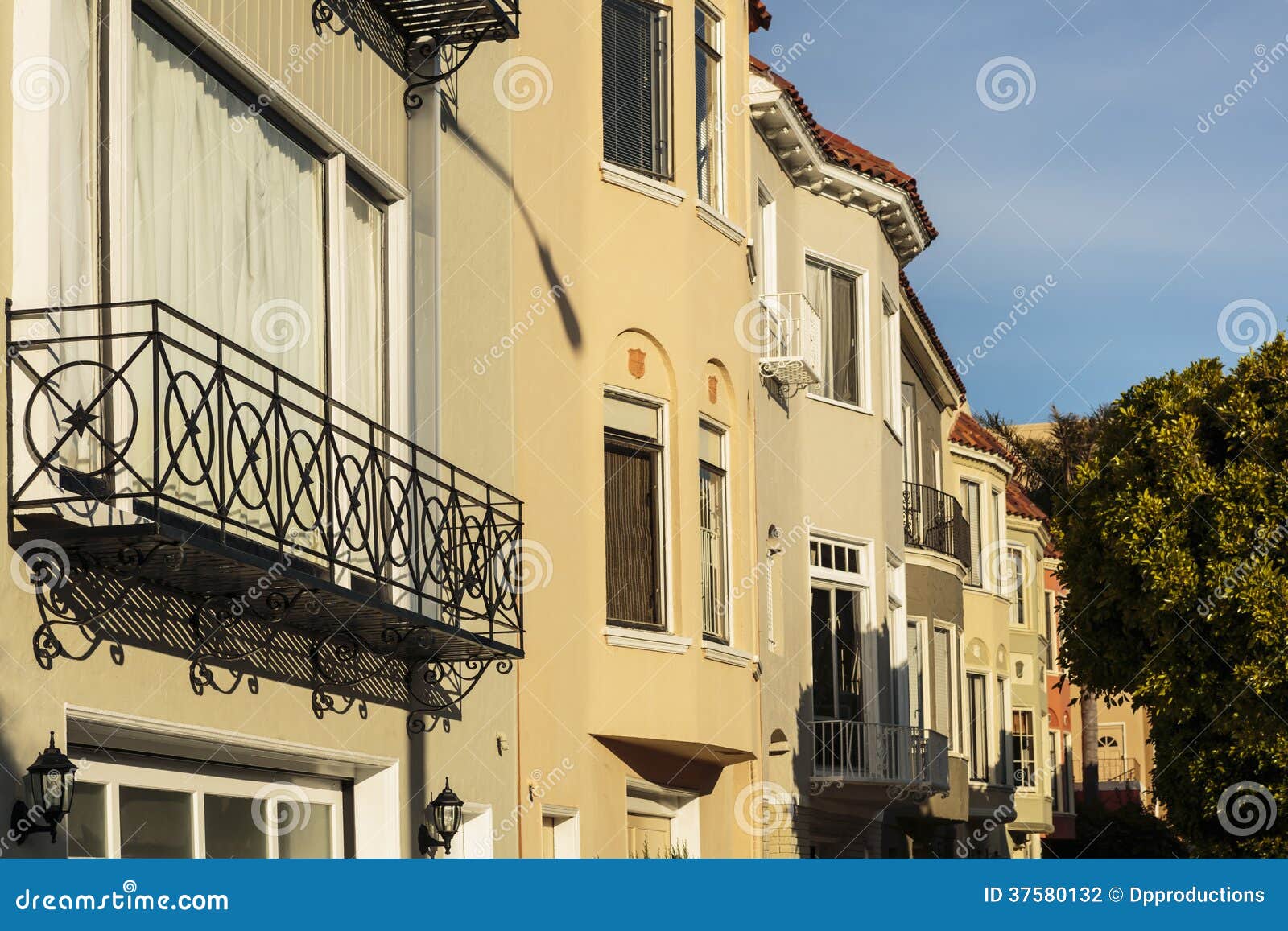 A Row of Beige Upscale Houses Against Blue Sky Stock Photo - Image of ...