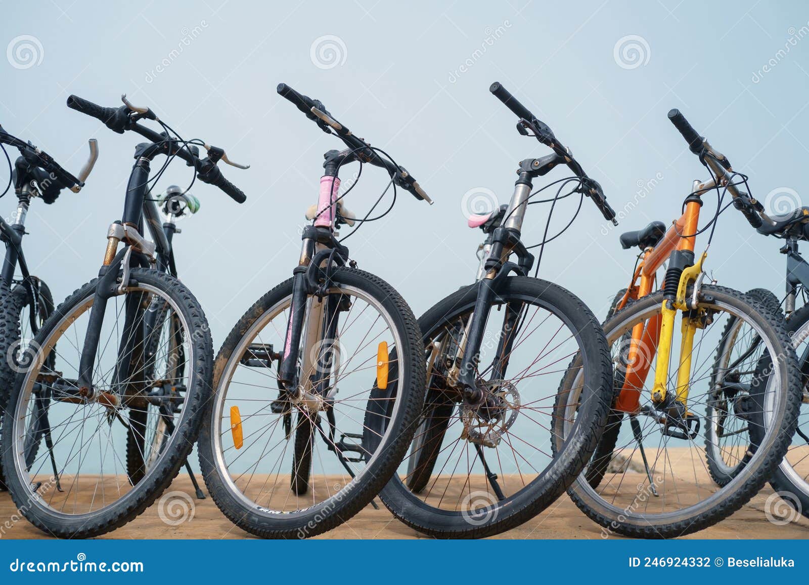 Row of bikes on the beach stock photo. Image of station - 246924332