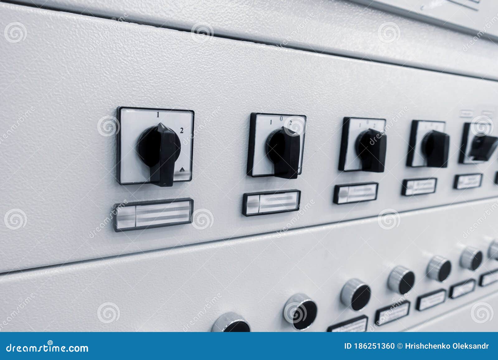 A Row of Black Plastic Electrical Switches on a White Metal Shield ...