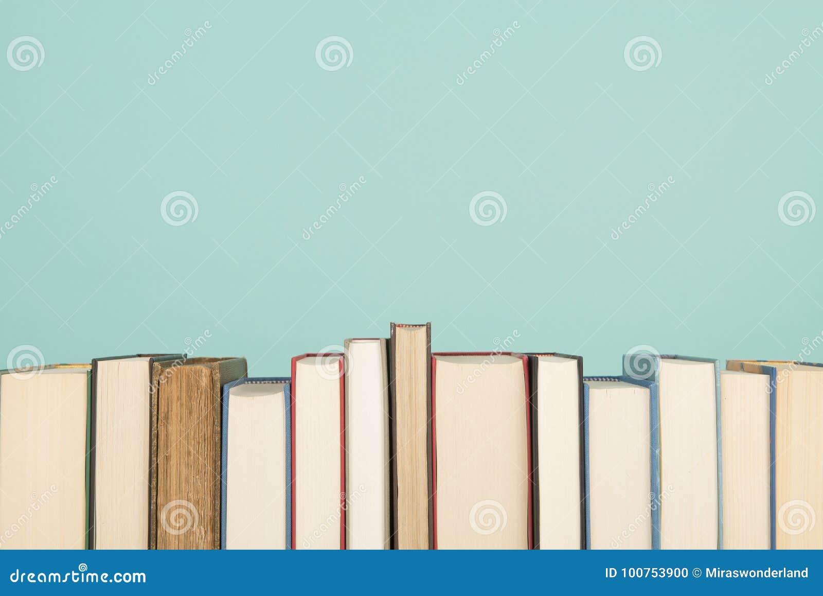 Row of Books on a Blue Background with Space for Copy Stock Photo ...