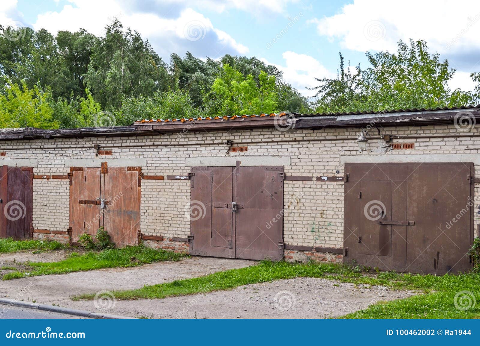 A Row of Brick Garages with Rusty Metal Gates. Russia Stock Photo ...