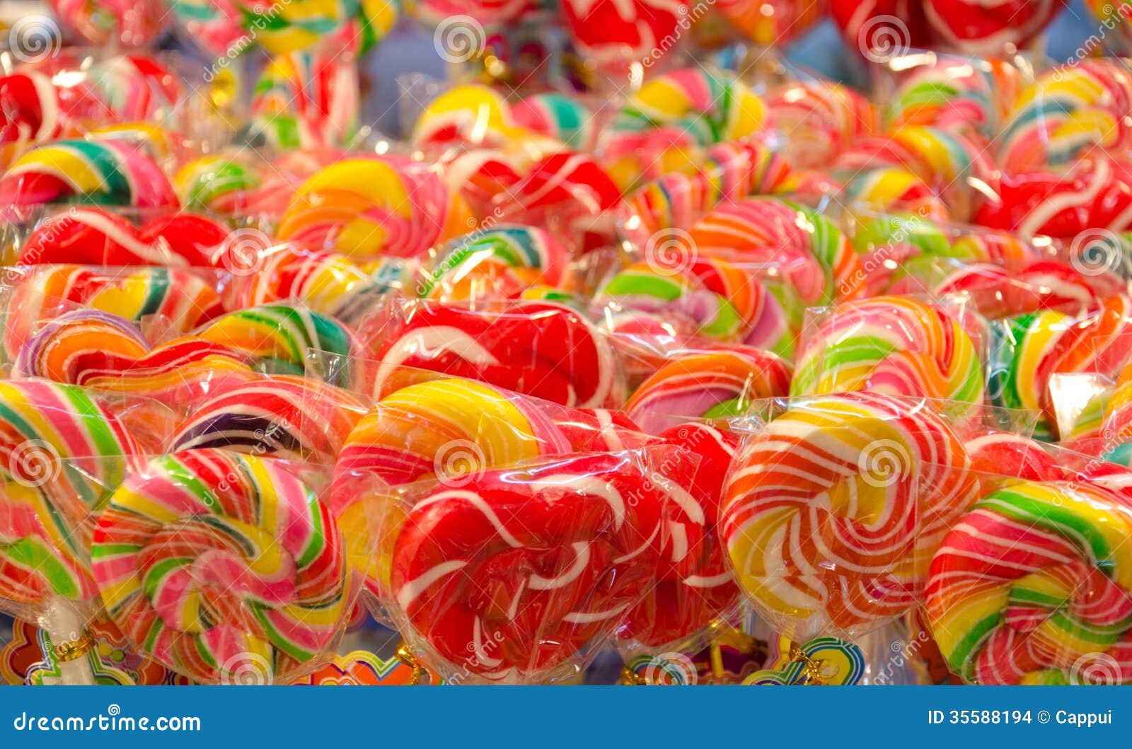 Row of bright lollipops stock photo. Image of striped - 35588194