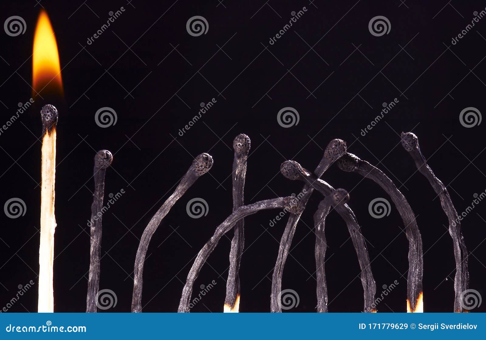 Row of Burned-out Matches Over the Black Background. One Match is ...