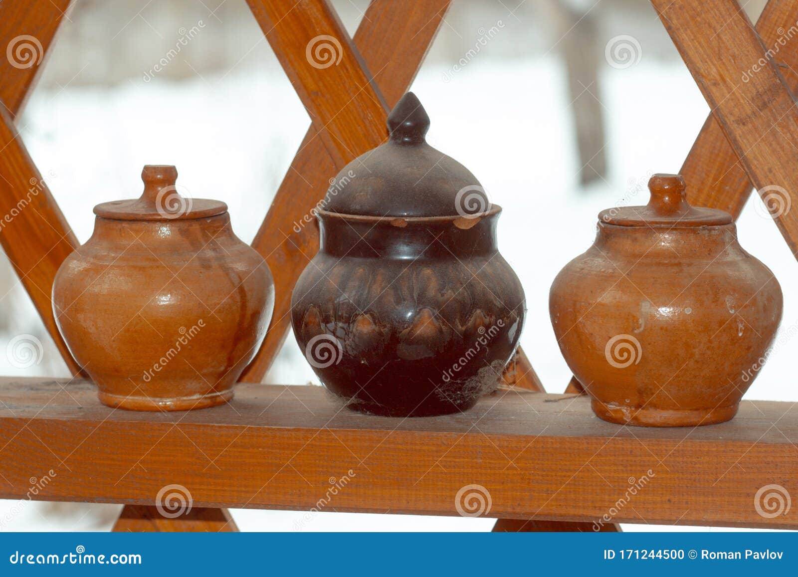 A Row of Clay Pots with Lids on the Shelf Stock Photo - Image of ...