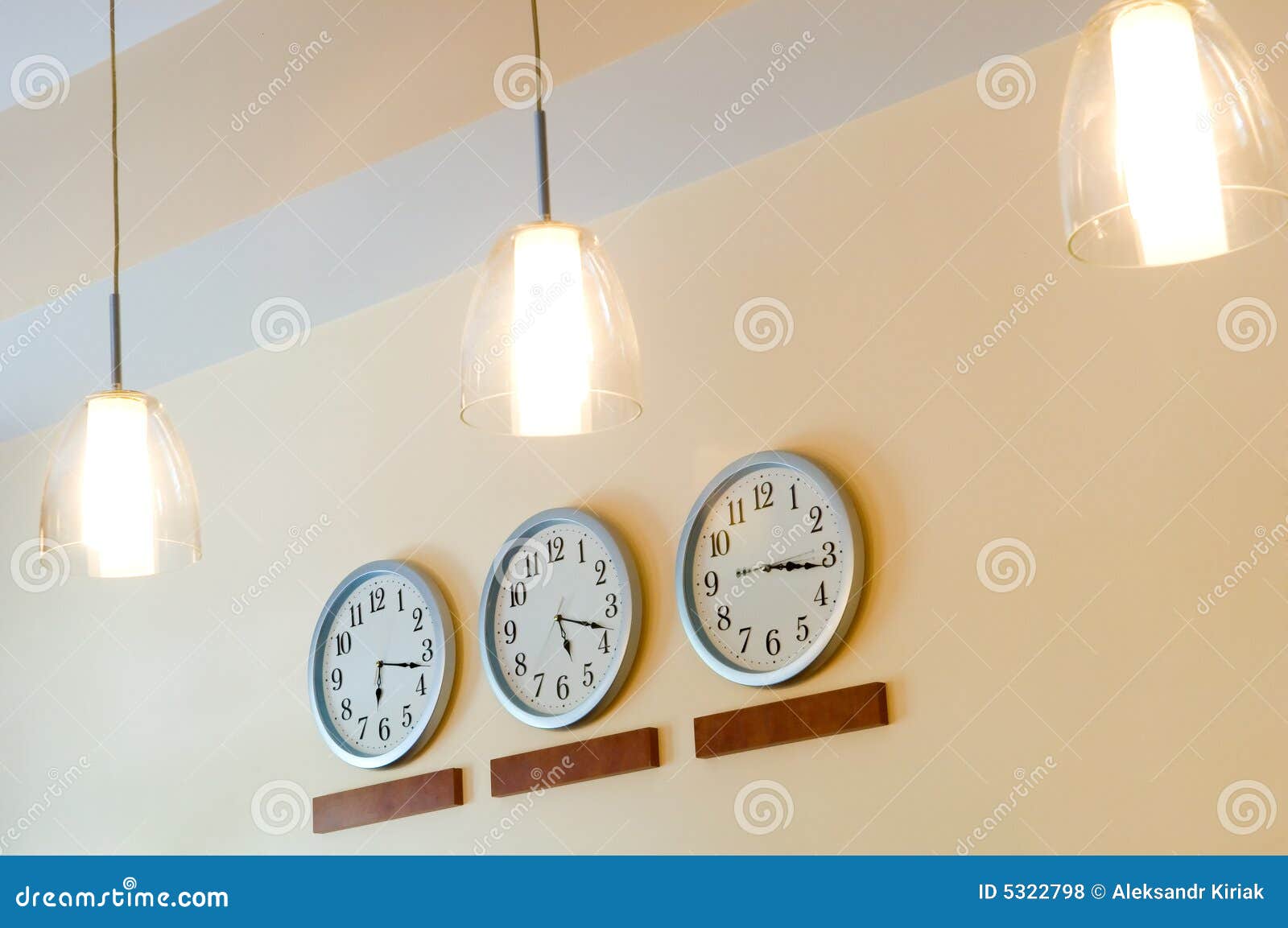 Row of Clocks Showing Different Time and Lamps Stock Photo - Image of ...