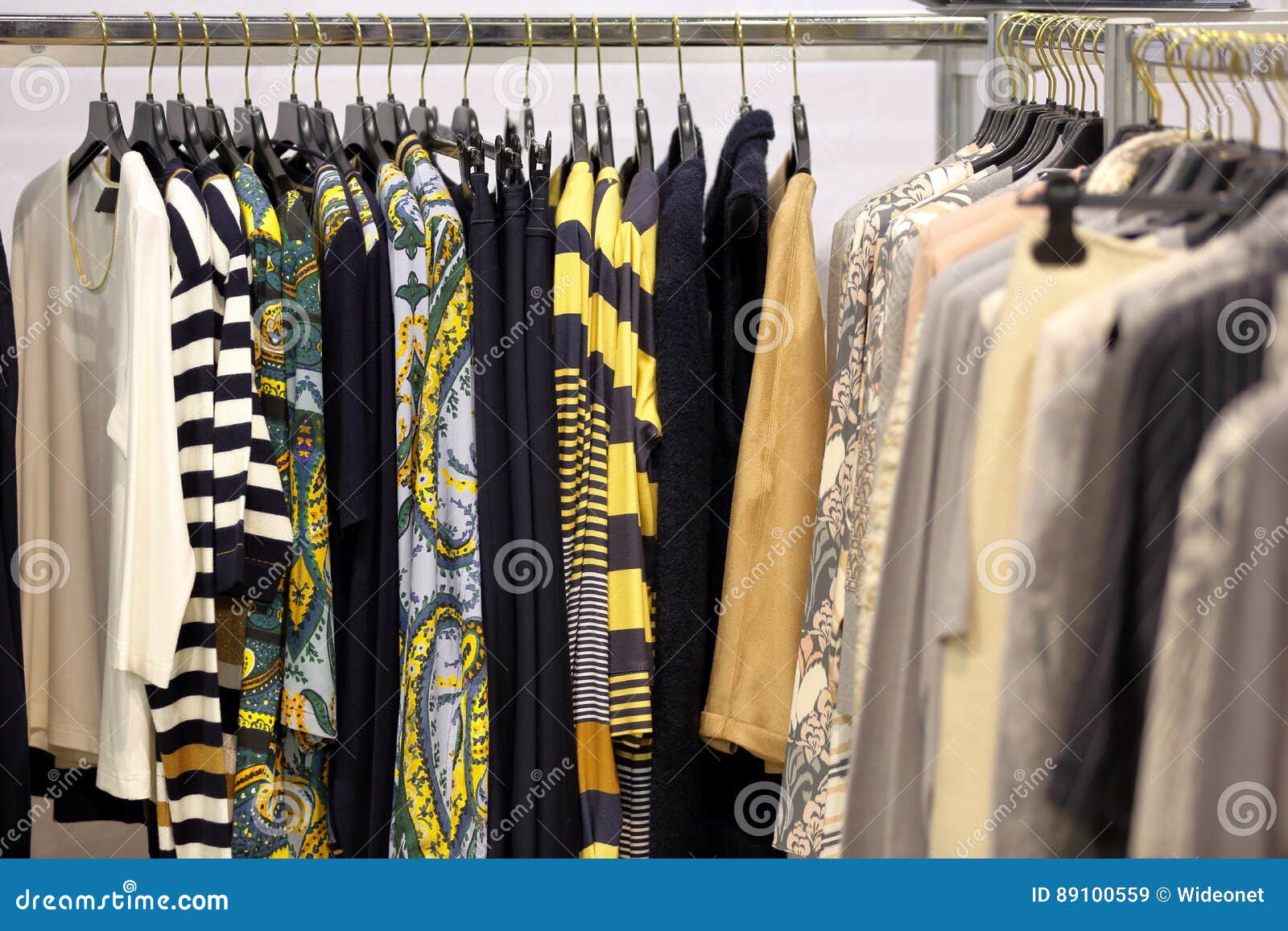 Row of Clothes Hanging in Wardrobe or Store Stock Image - Image of ...