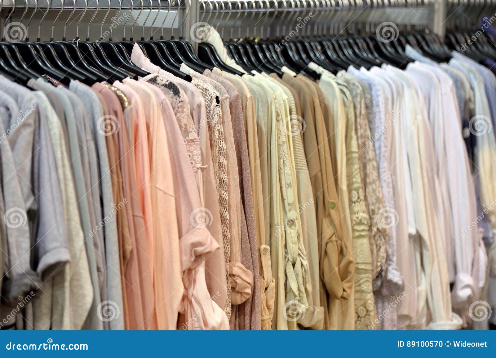 Row of Clothes Hanging in Wardrobe or Store Stock Photo - Image of ...