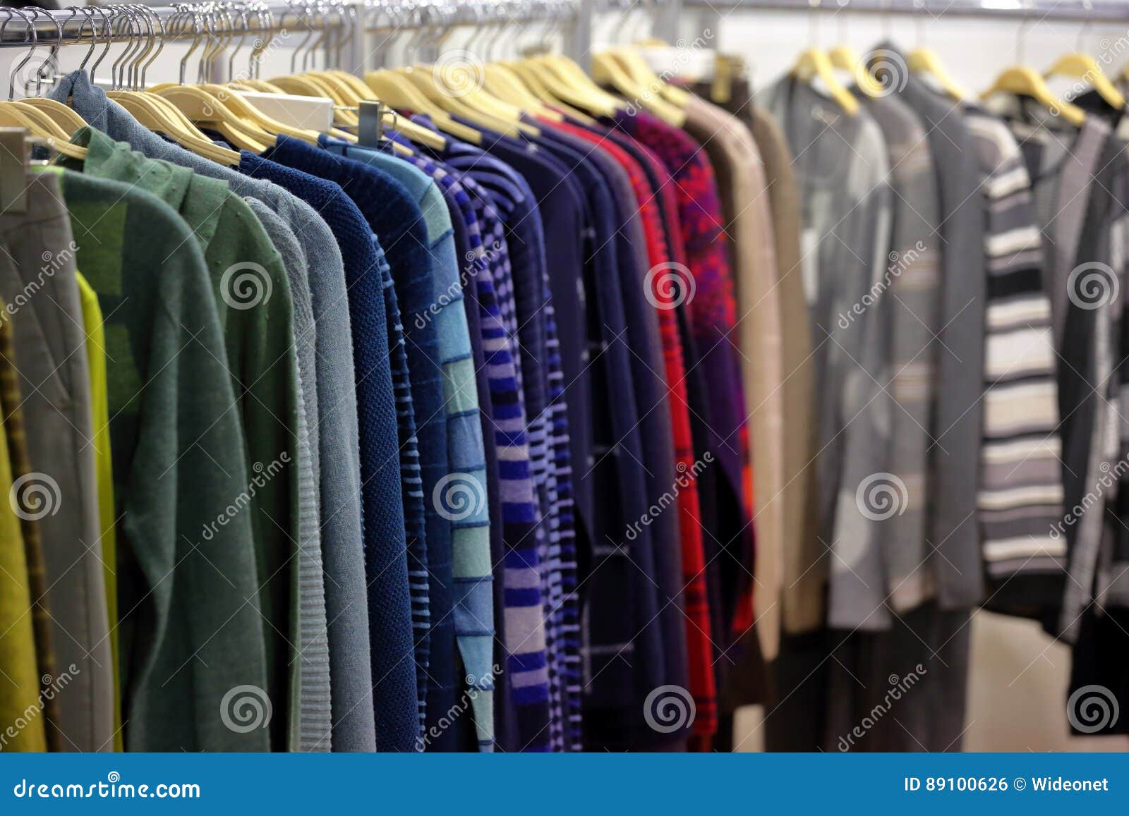 Row of Clothes Hanging in Wardrobe or Store Stock Photo - Image of ...