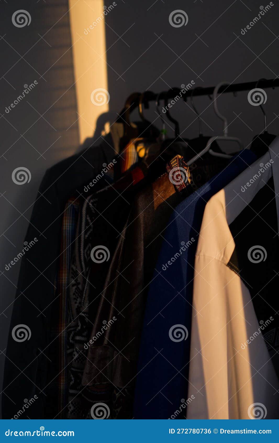 Row of Clothing Items, Including Shirts, Hung on a Rack Stock Photo ...