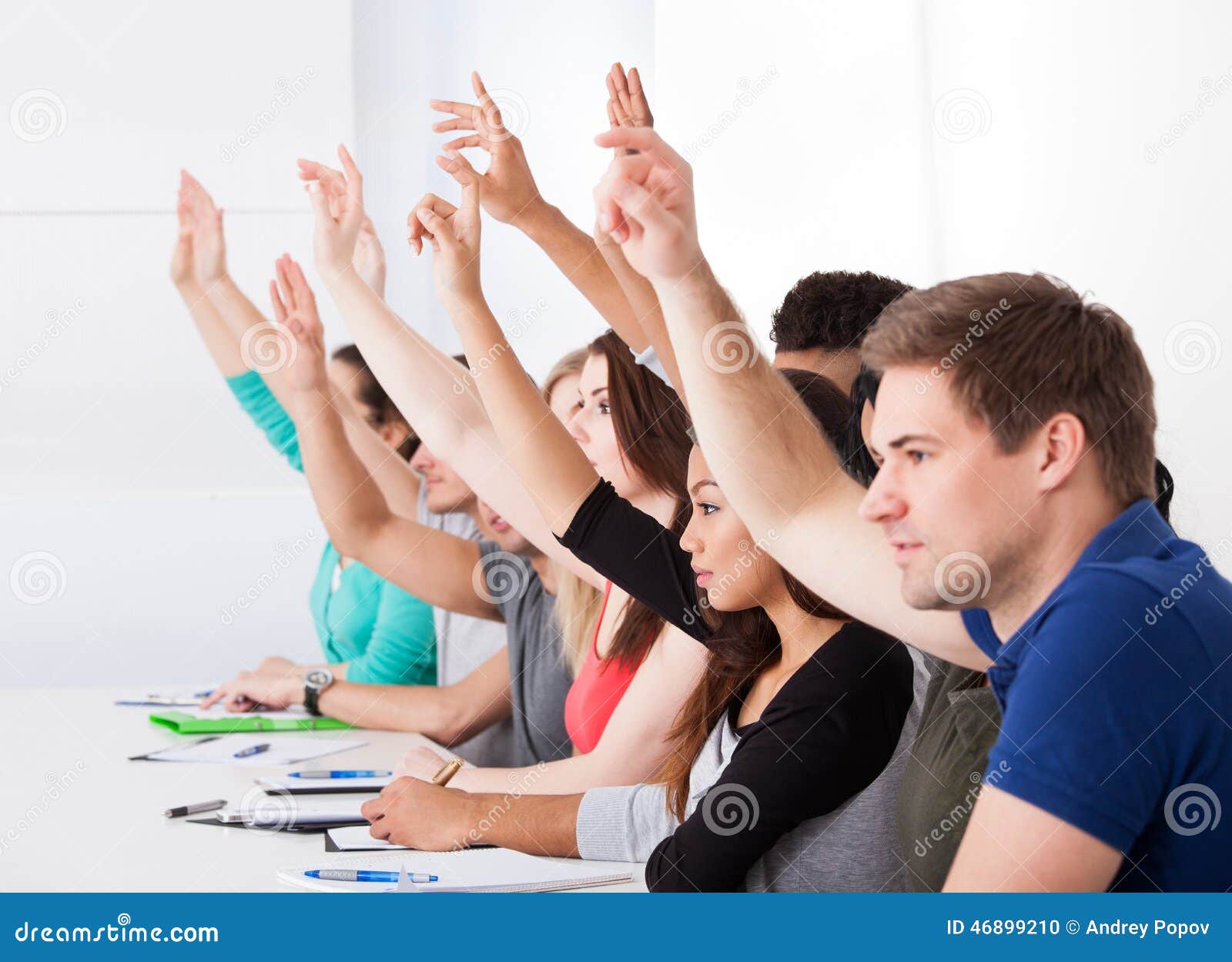 College Student Raising Hand In Class