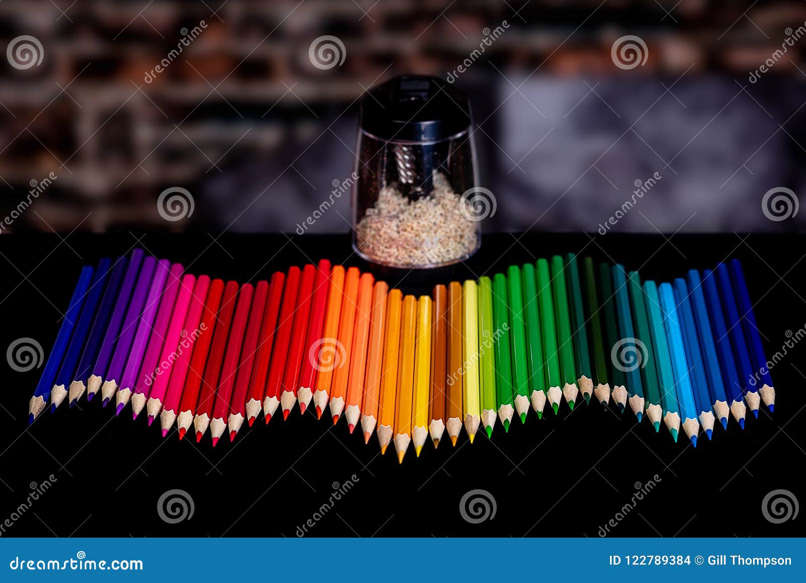 A Row of Colored Pencils Lined Up in a Wavy Pattern with a Blurry ...