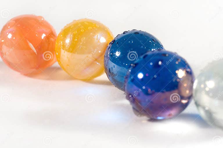Row of colorful marbles stock photo. Image of abstract - 7379612