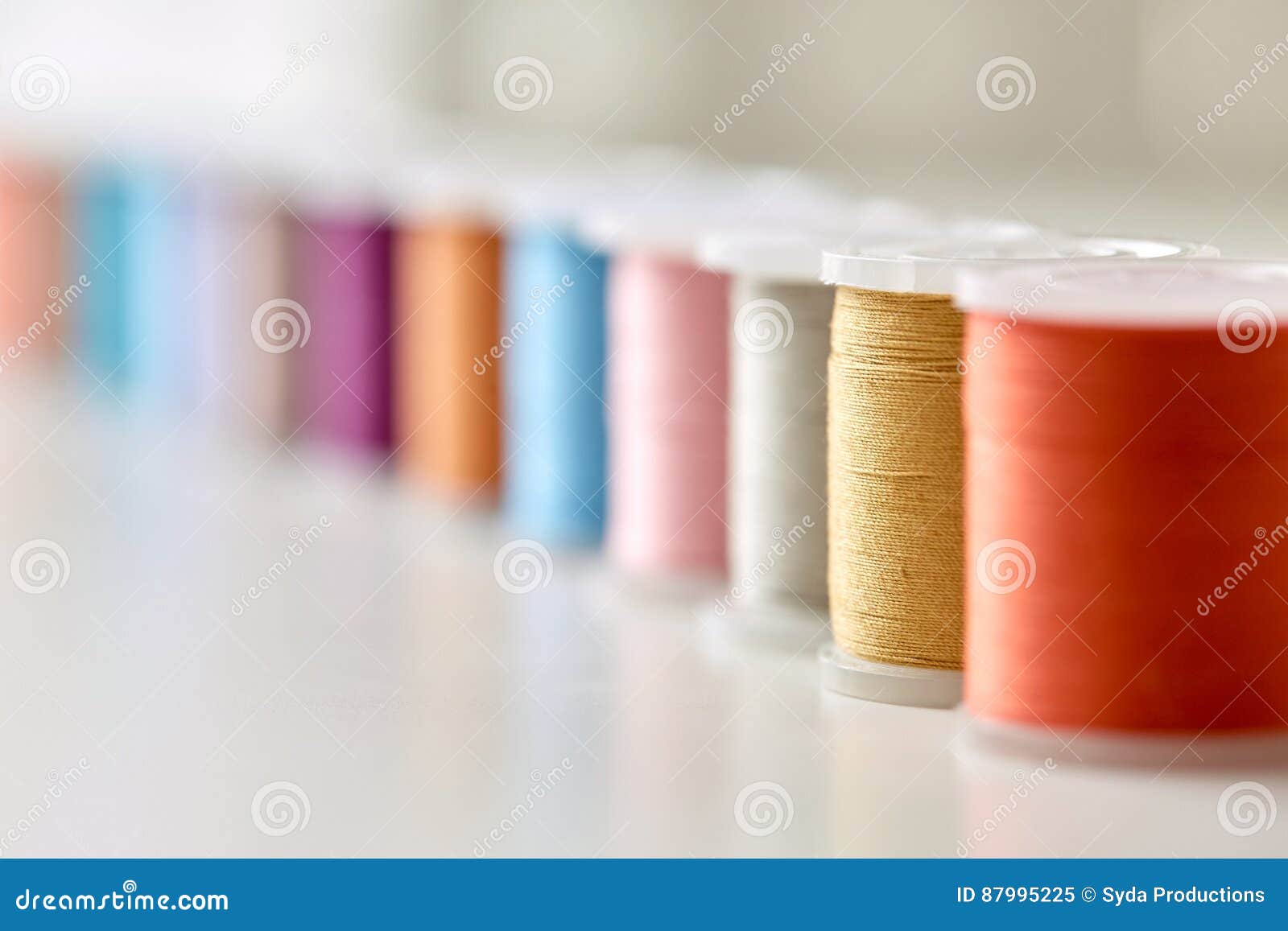 Row of Colorful Thread Spools on Table Stock Image - Image of stitching ...