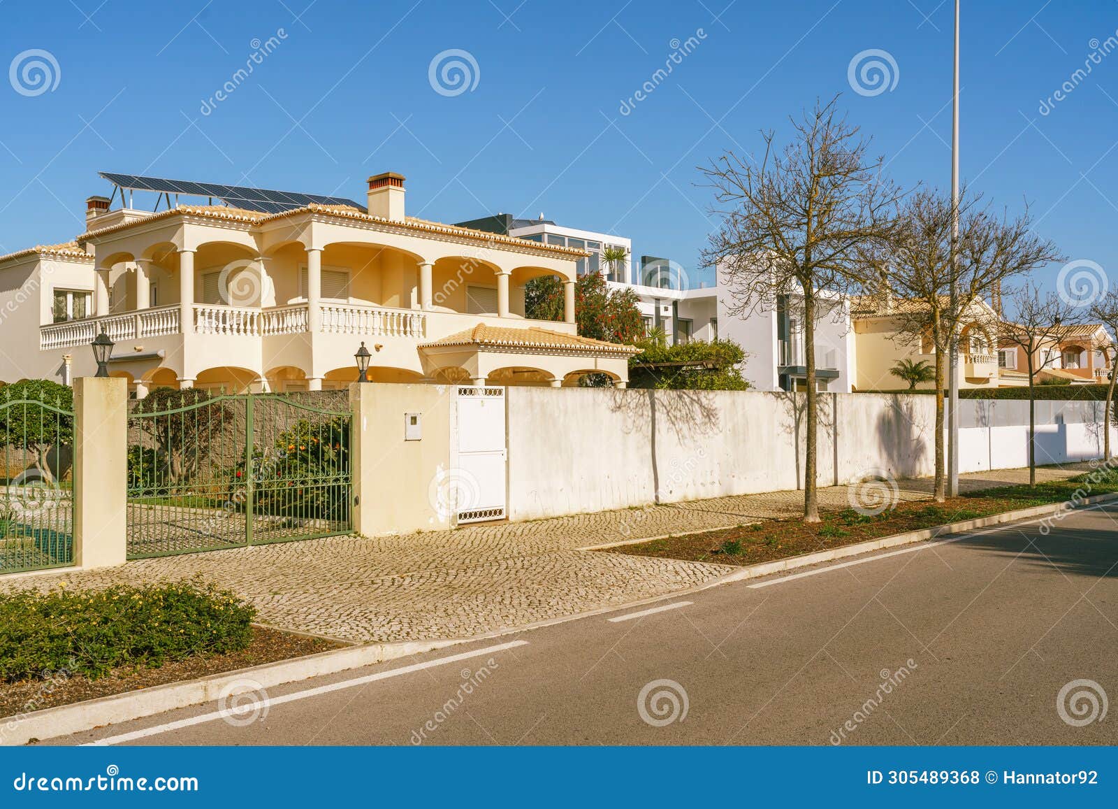 Row of Condos Lining the Street, Blue Sky in the Background Stock Photo ...