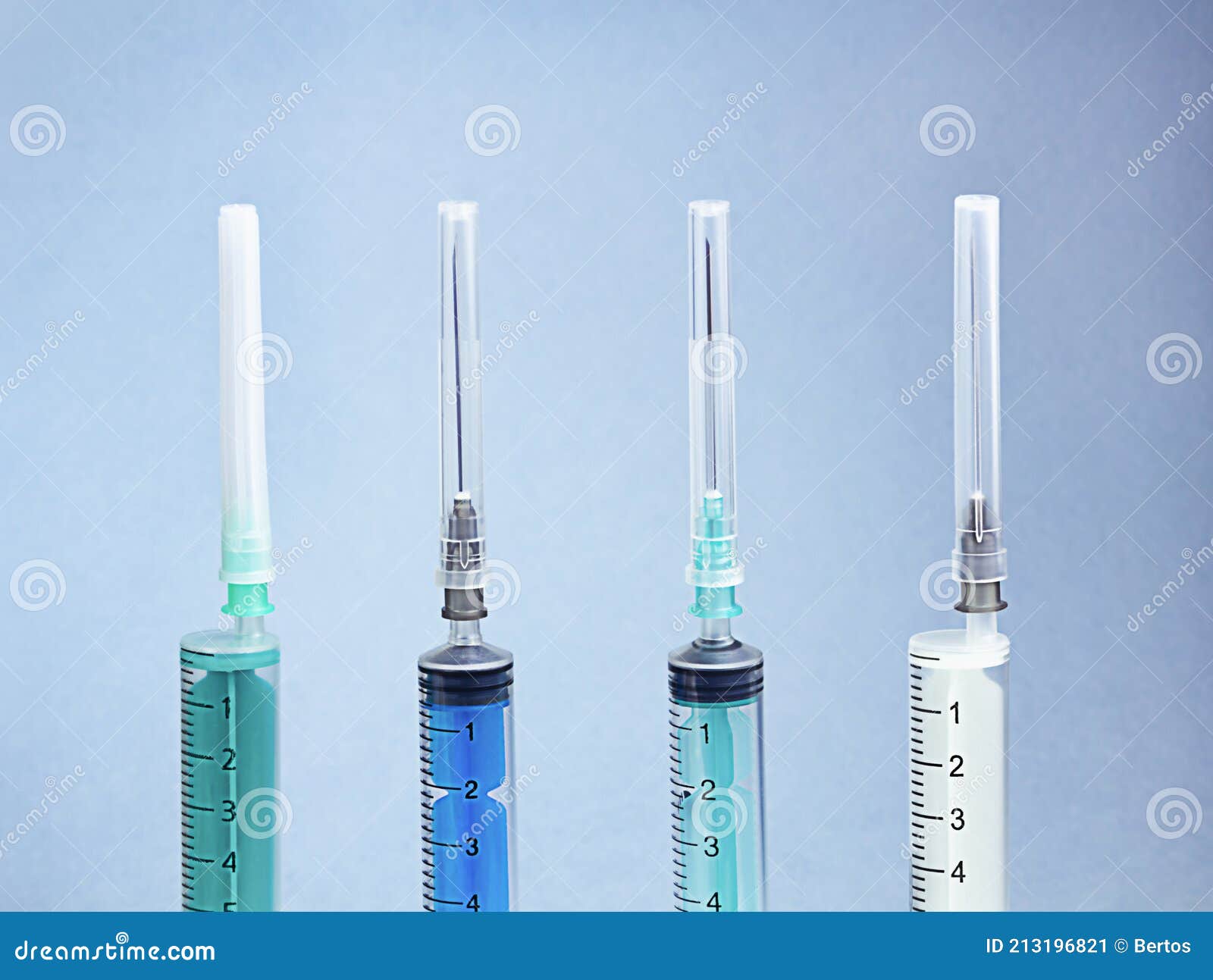 Row of Different Disposable Syringes on Blue Background Stock Image ...