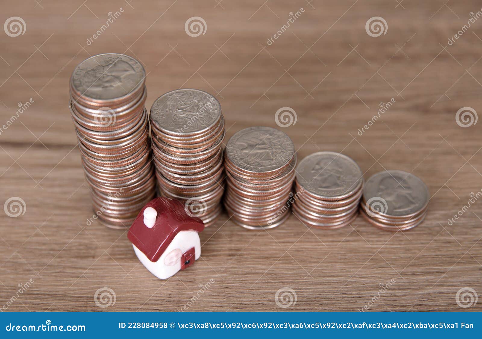 A Row of Dollar Coins and a Small House Model in a Trough Stock Photo ...