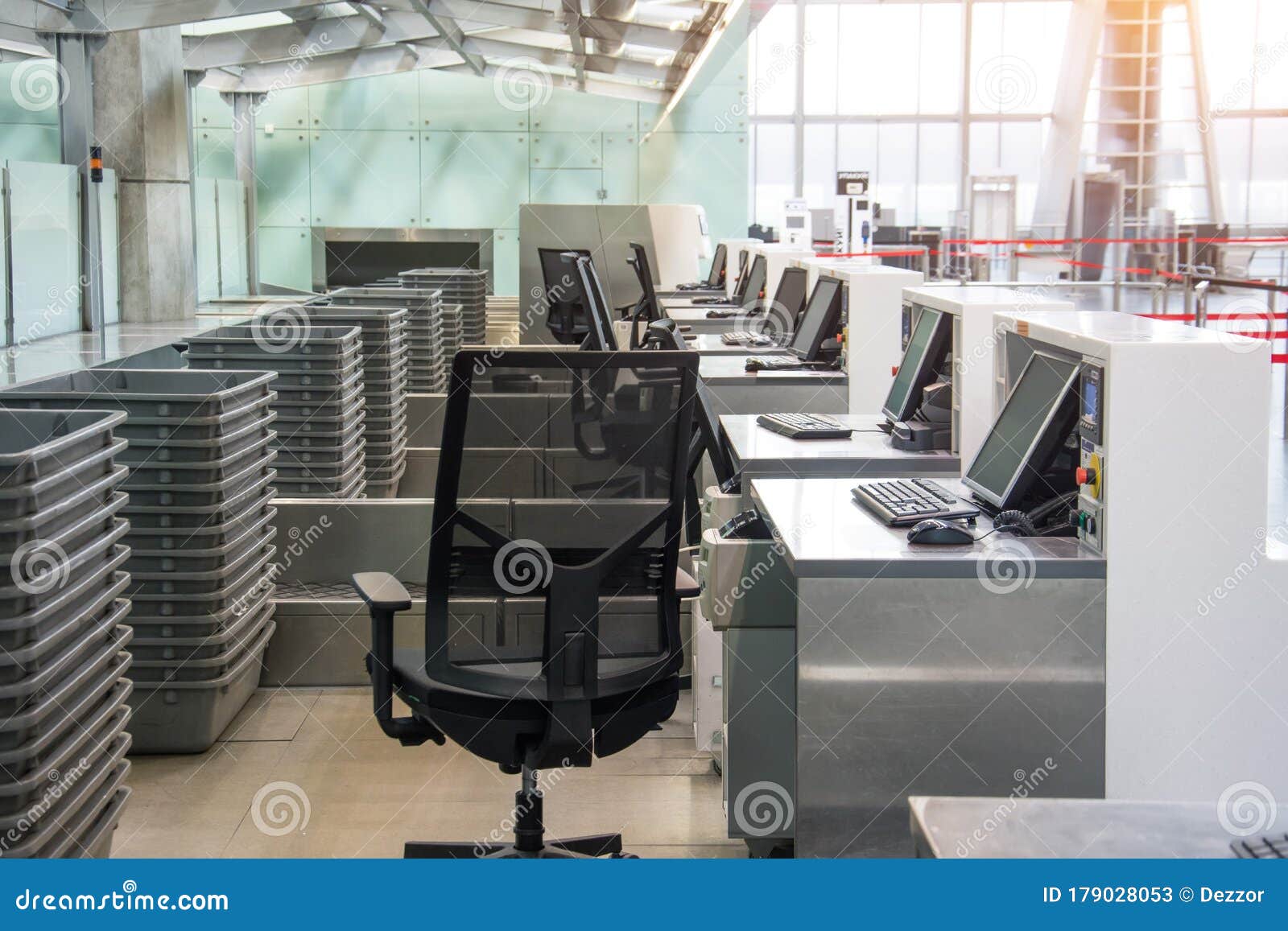 Row of Empty Check-in Desks with Luggage Boxes Computer Monitors at the ...