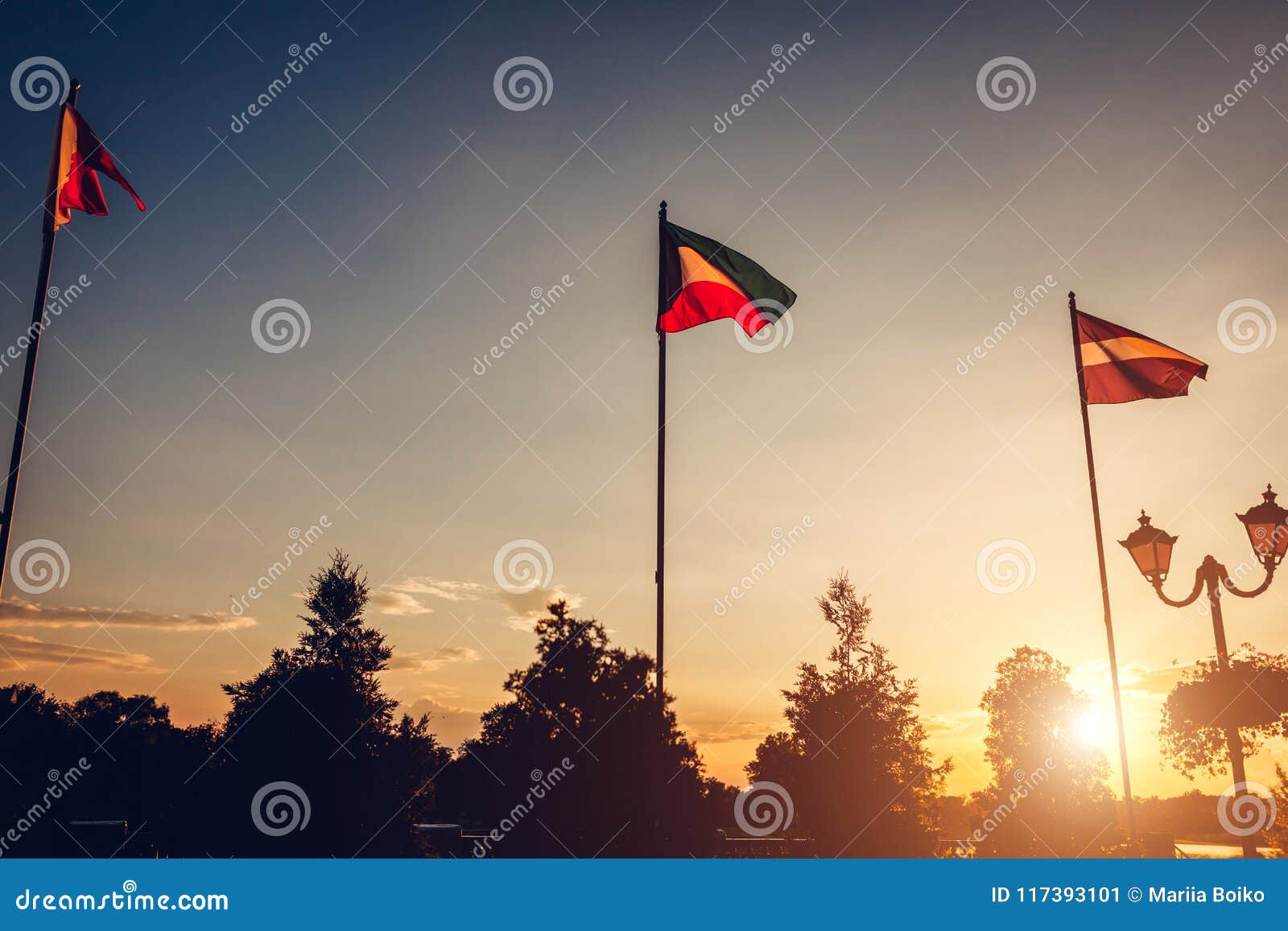A Row of Flying Flags of Nations on Sunset Sky Background. Flags of ...