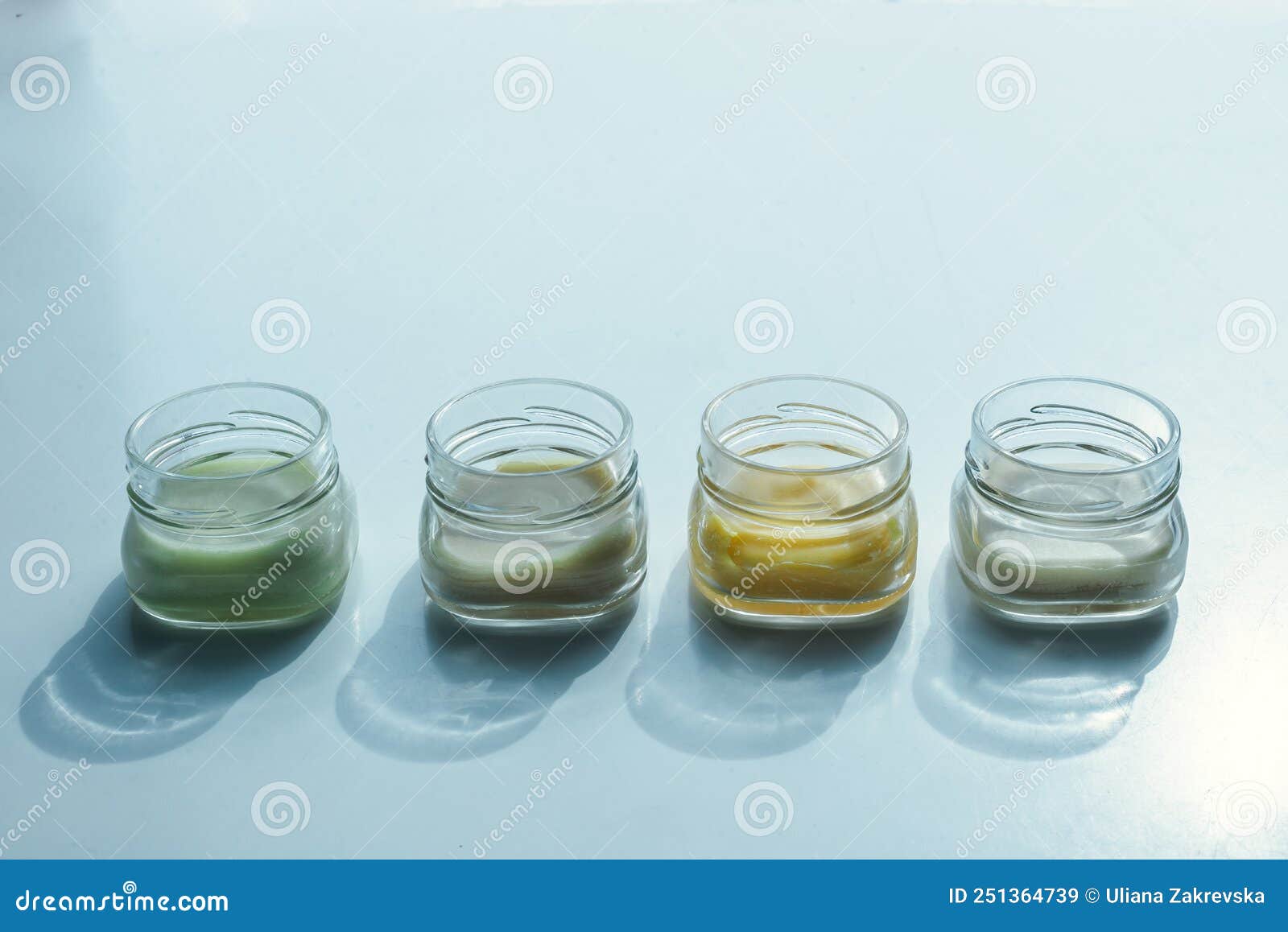 Row Of Four Jars With Cream On White Surface In A Hard Light Stock Image Image Of Pastel