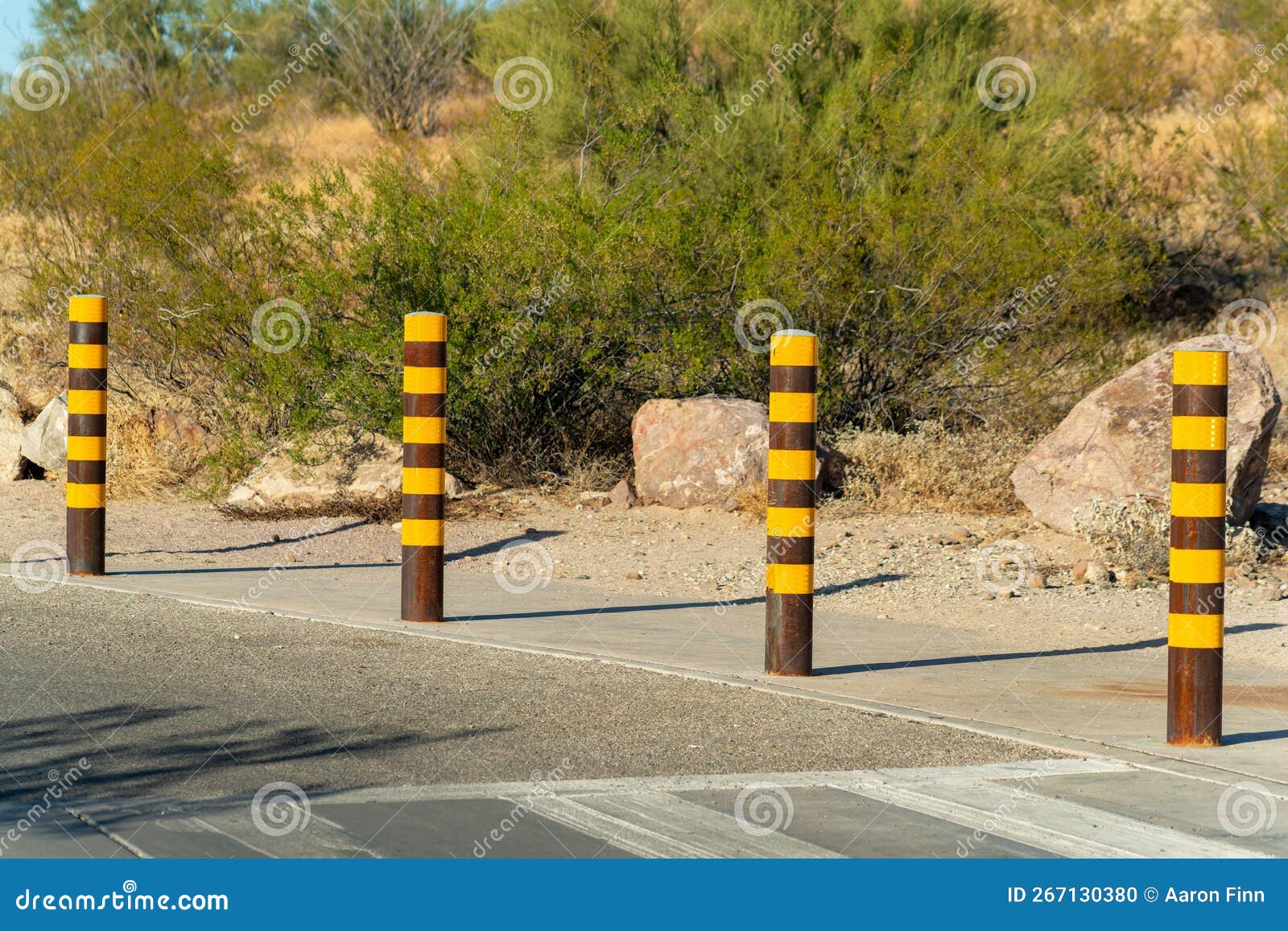 Row of Four Metal Poles To Keep Cars from Driving in a Certain Area ... Row of Four Metal Poles To Keep Cars from Driving in a Certain Area ...