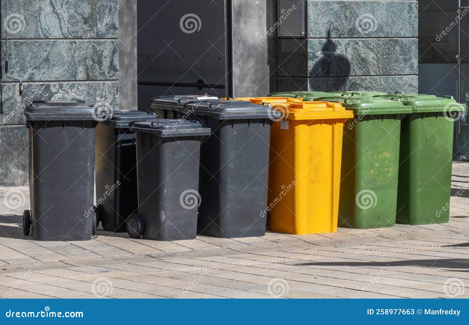 Row of garbage cans stock image. Image of dustbin, yellow - 258977663