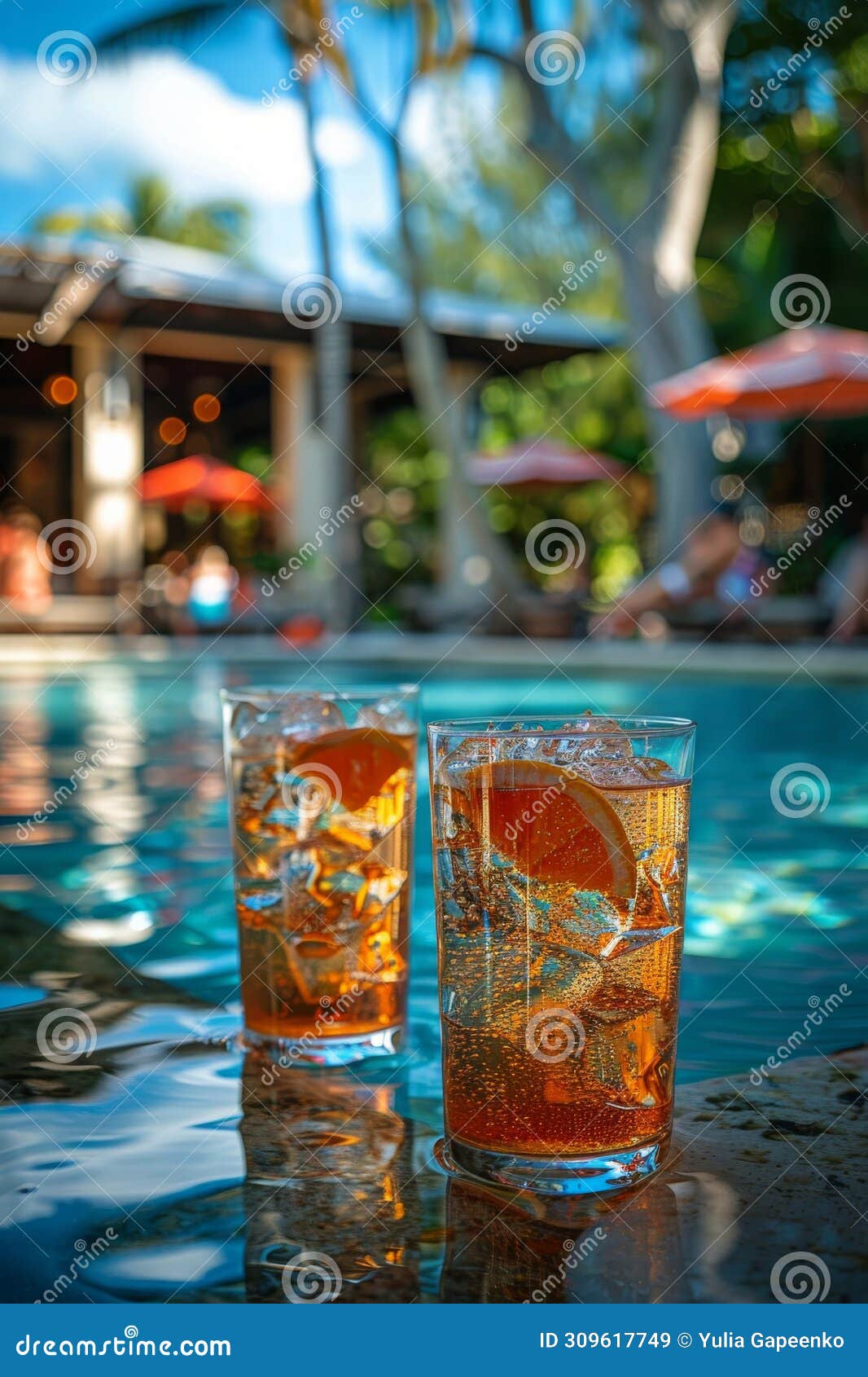 Row of Glasses Filled with Drinks Overlooking Swimming Pool Stock Image ...