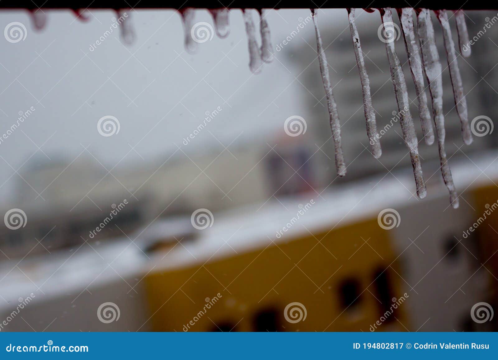 Row of Icicles at the Window with Buildings in the Background Stock ...
