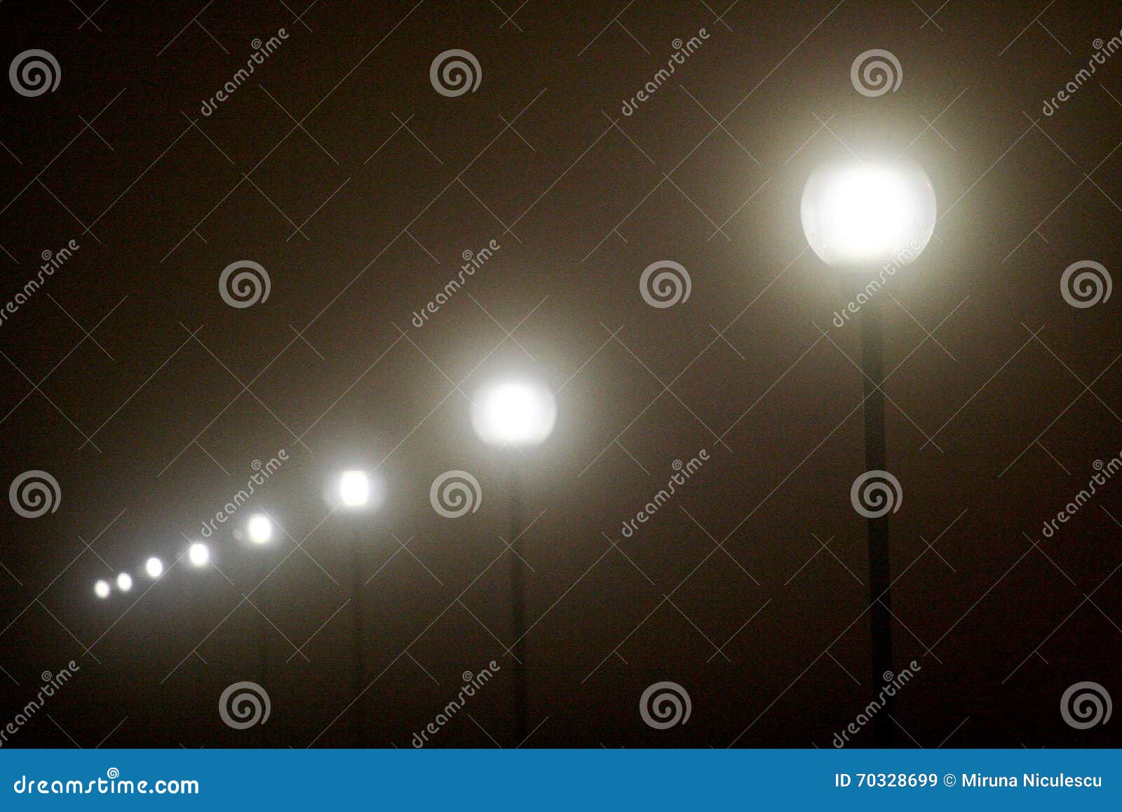 Row of Lamp Posts Glowing in the Dark Stock Image - Image of ...