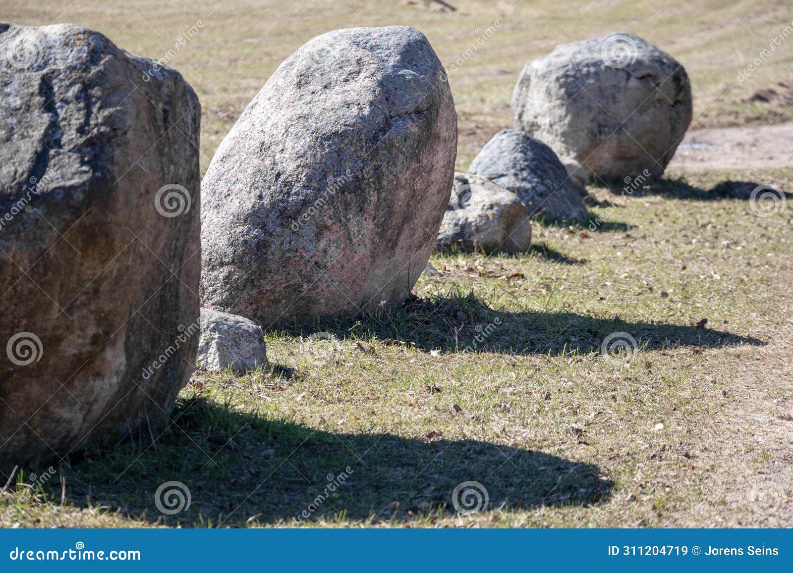 A Row of Large Boulders by the Side of the Street on the Grass Stock ...