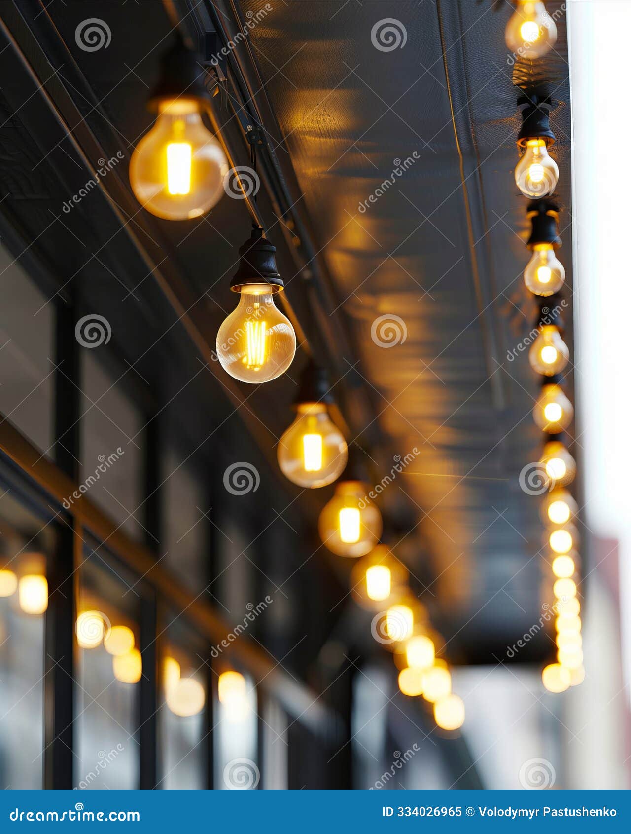 A Row of Light Bulbs Hanging from the Side of a Building Stock Image ...