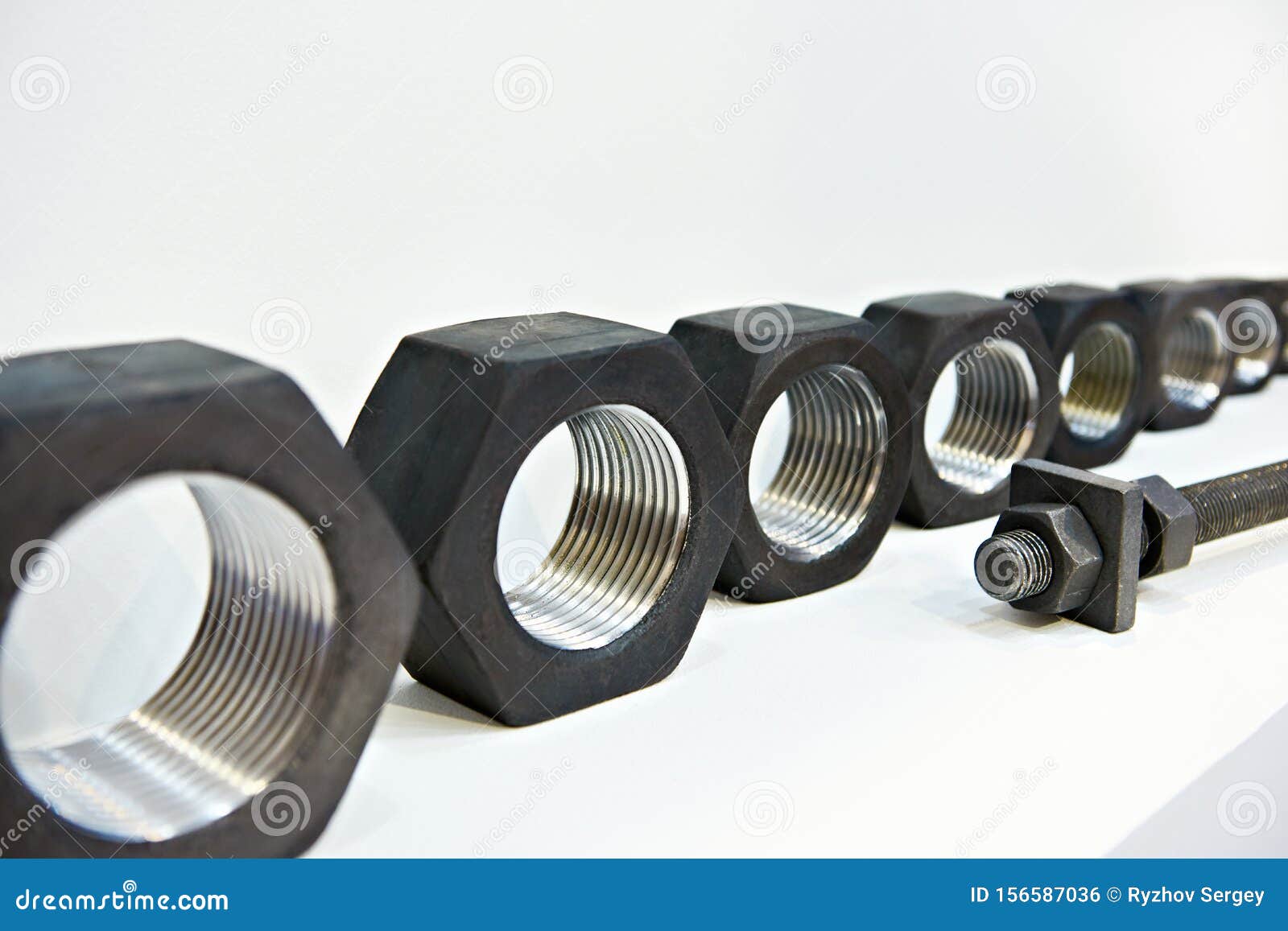 Row of metal nuts stock photo. Image of equipment, metallic - 156587036