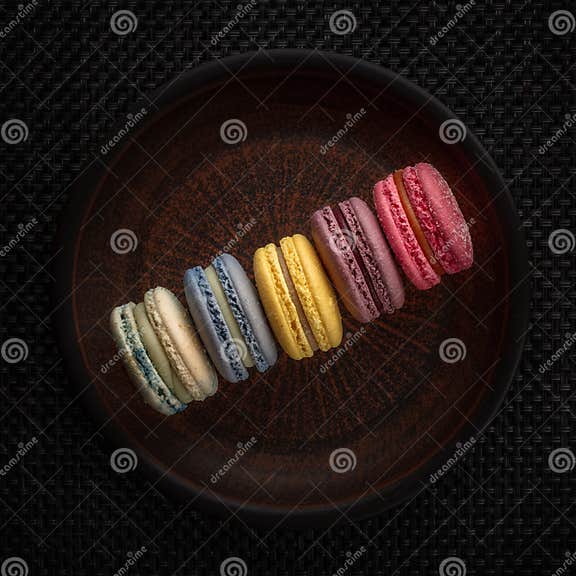 Five Colored Macarons on the Brown Plate and Pattern Background Stock ...