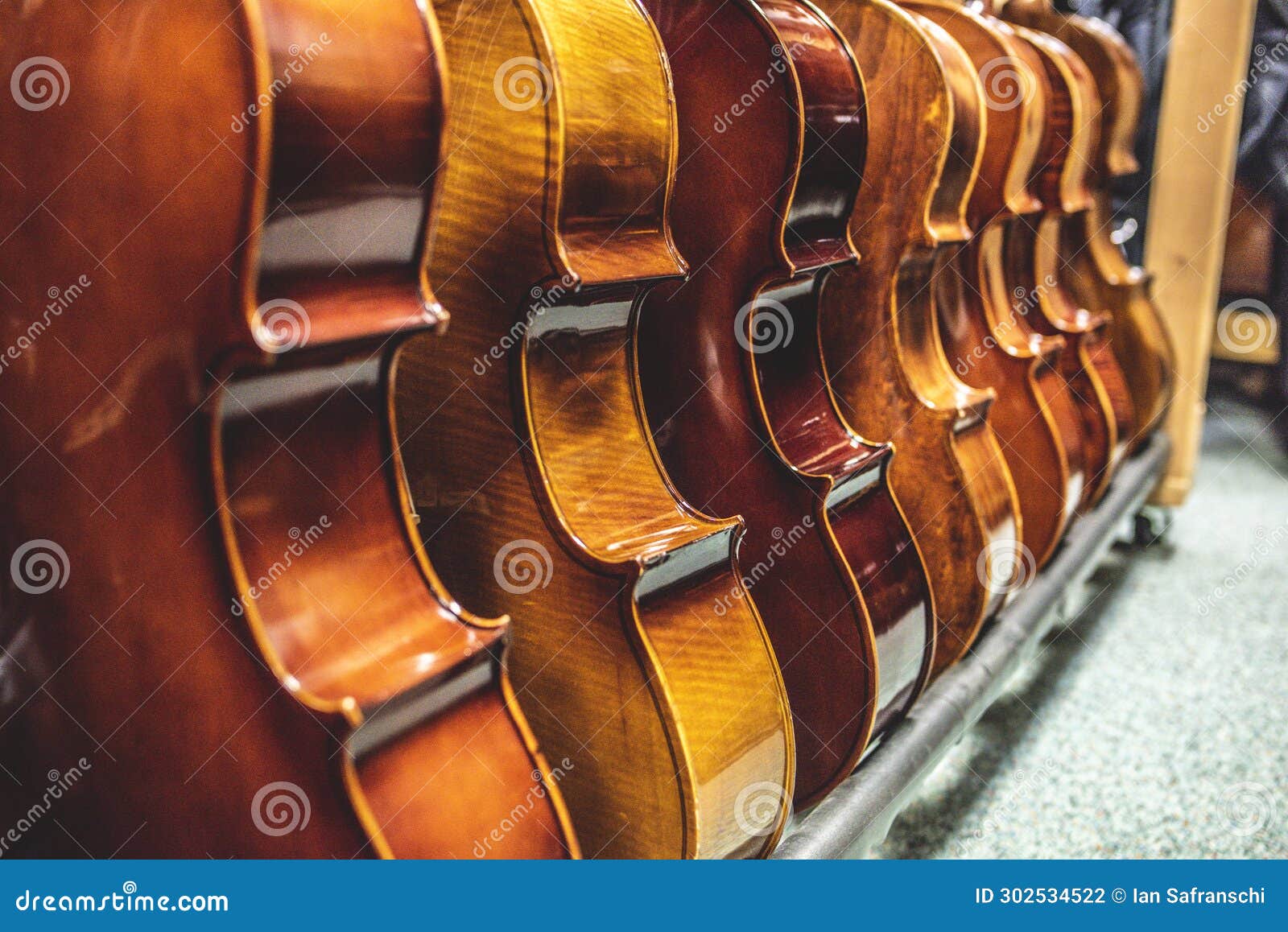 Row of Multiple Cellos Standing on the Floor at a Musician Workshop ...
