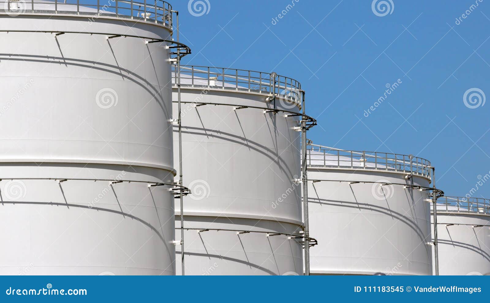 Row of oil storage tanks stock image. Image of industry - 111183545