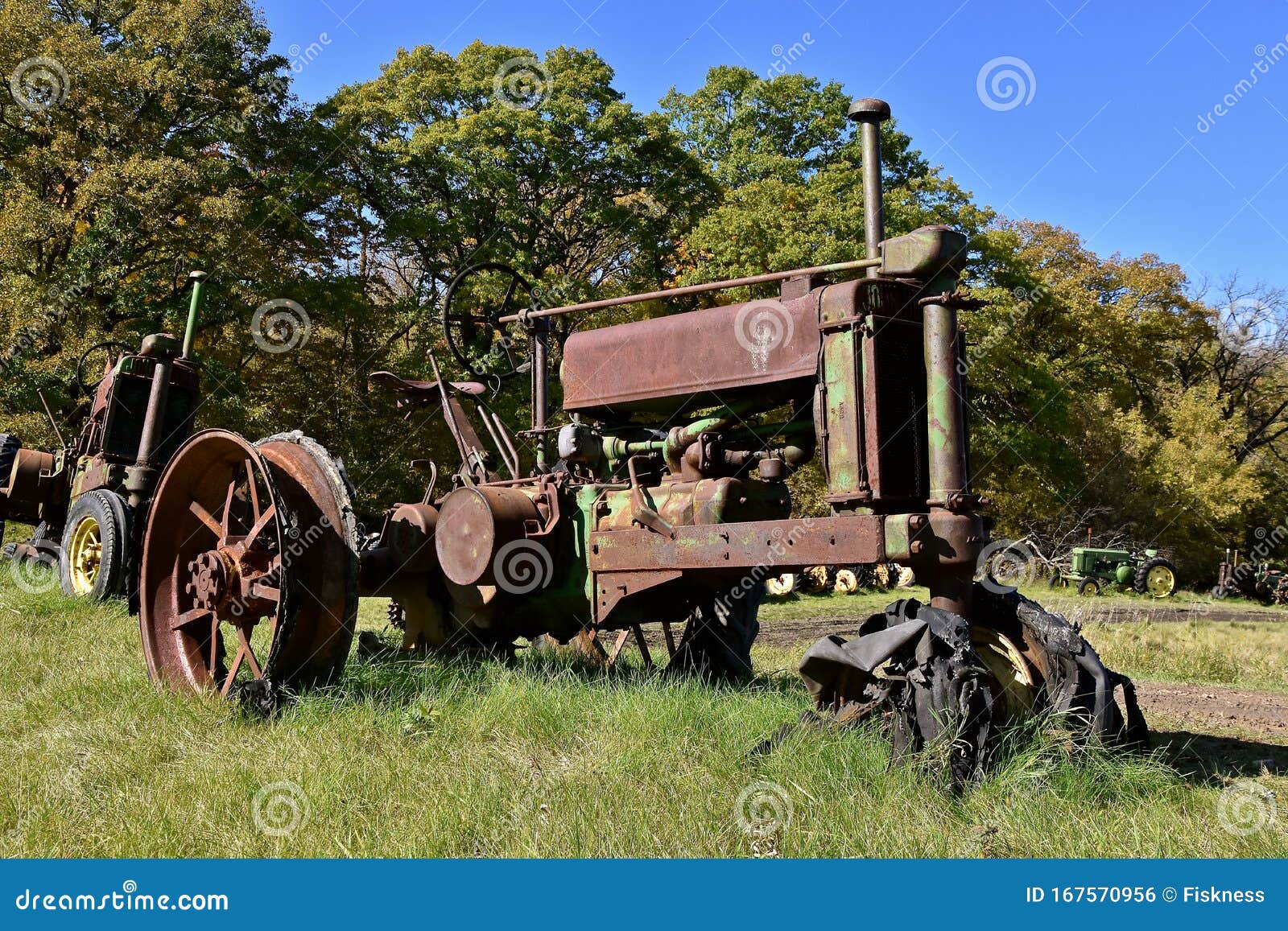Row of old rusty tractors stock photo. Image of equipment - 167570956