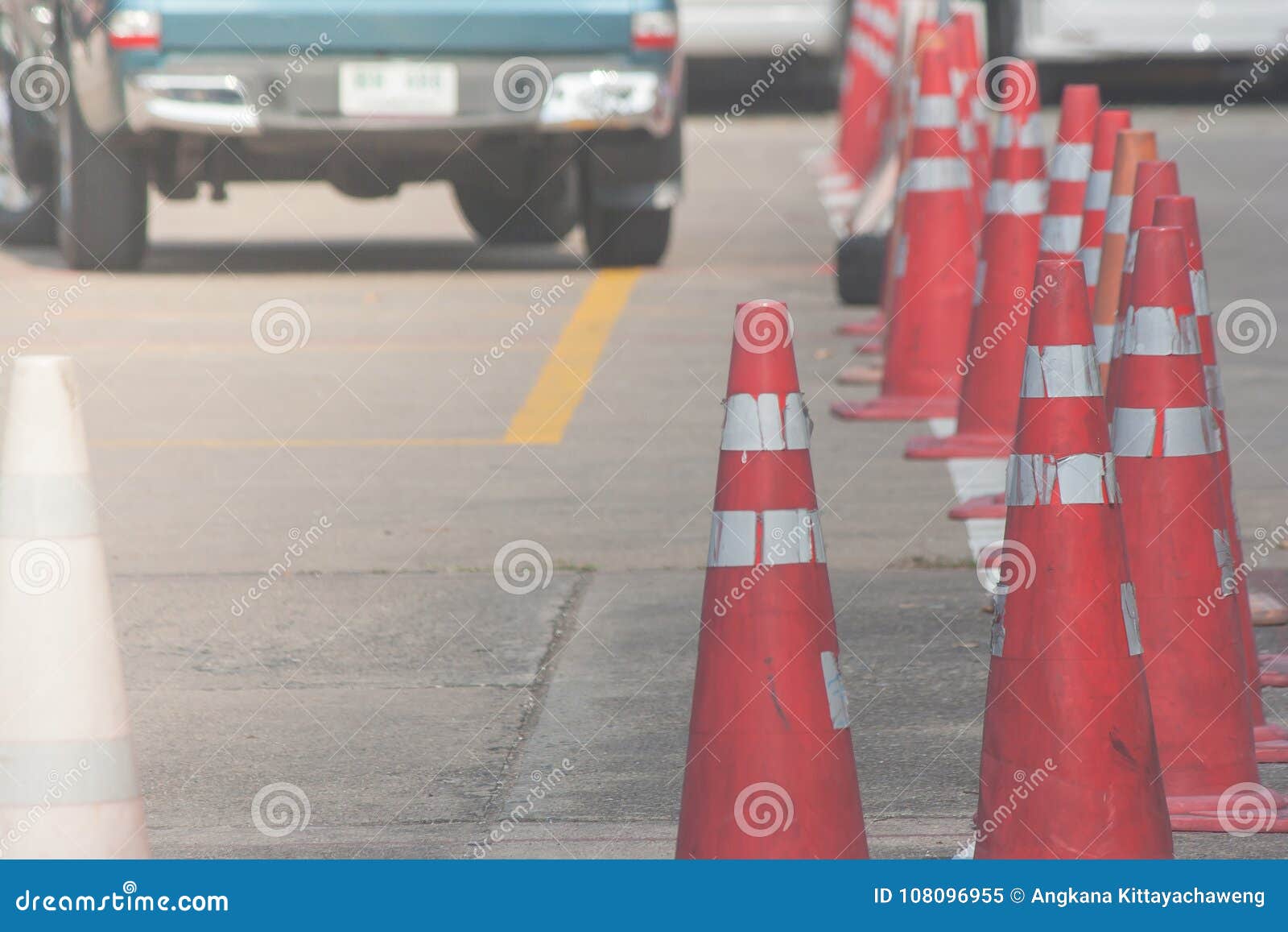 Row of Orange Traffic Cones Setting on Roadway beside Parking Lot ...