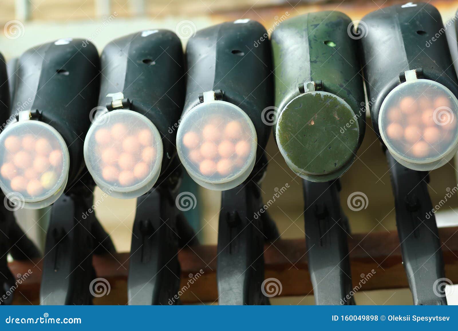 Row of Paintball Guns on a Rack Stock Photo - Image of entertainment ...