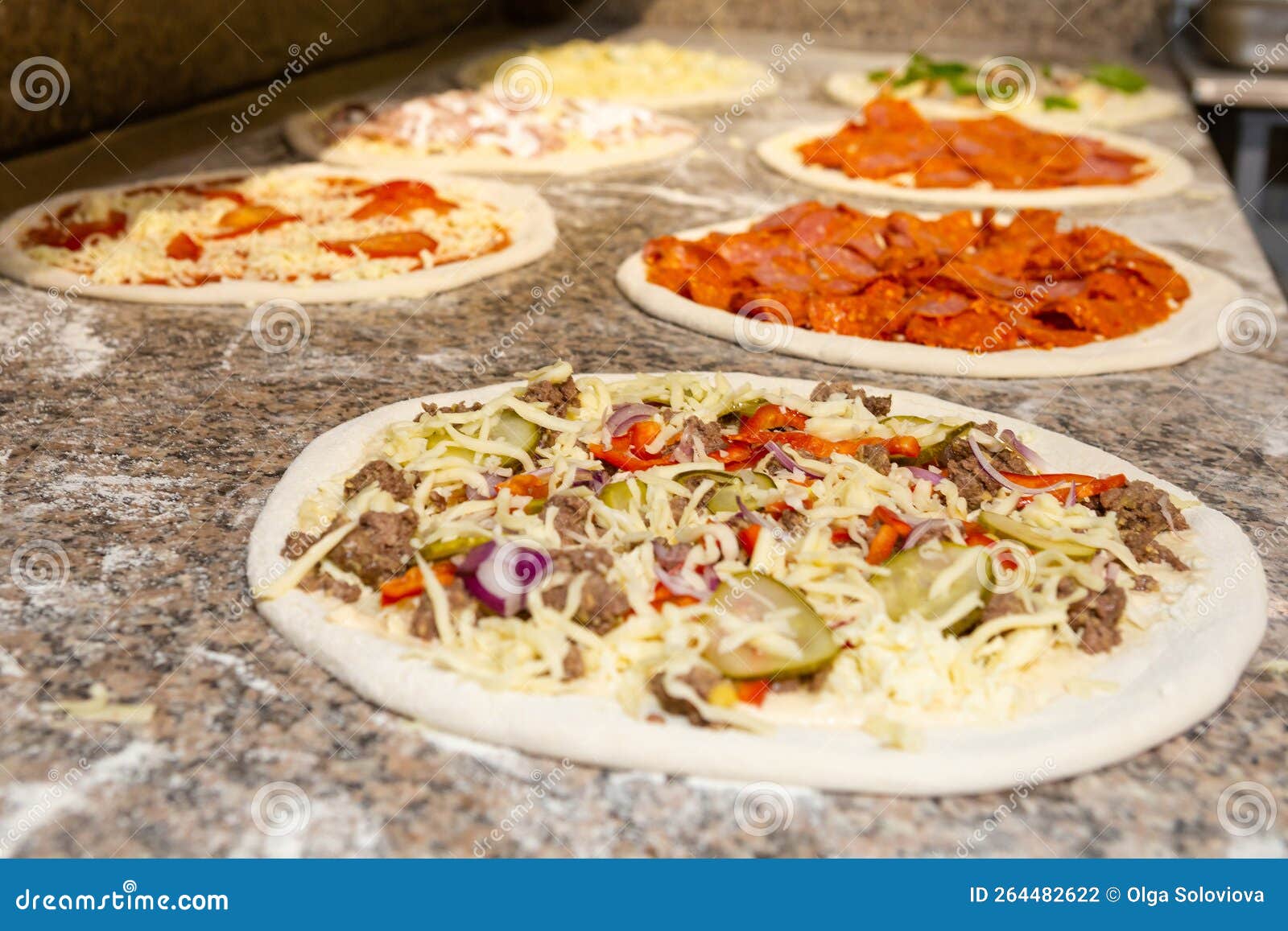 Row Pizza with Cheese Prepared for Baking. Pizza Making Process, Row ...