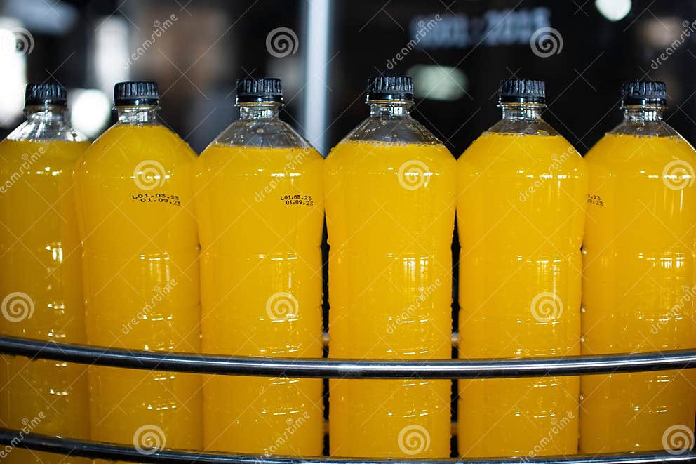 Row of Plastic Bottles Being Filled with Liquid Stock Image - Image of ...