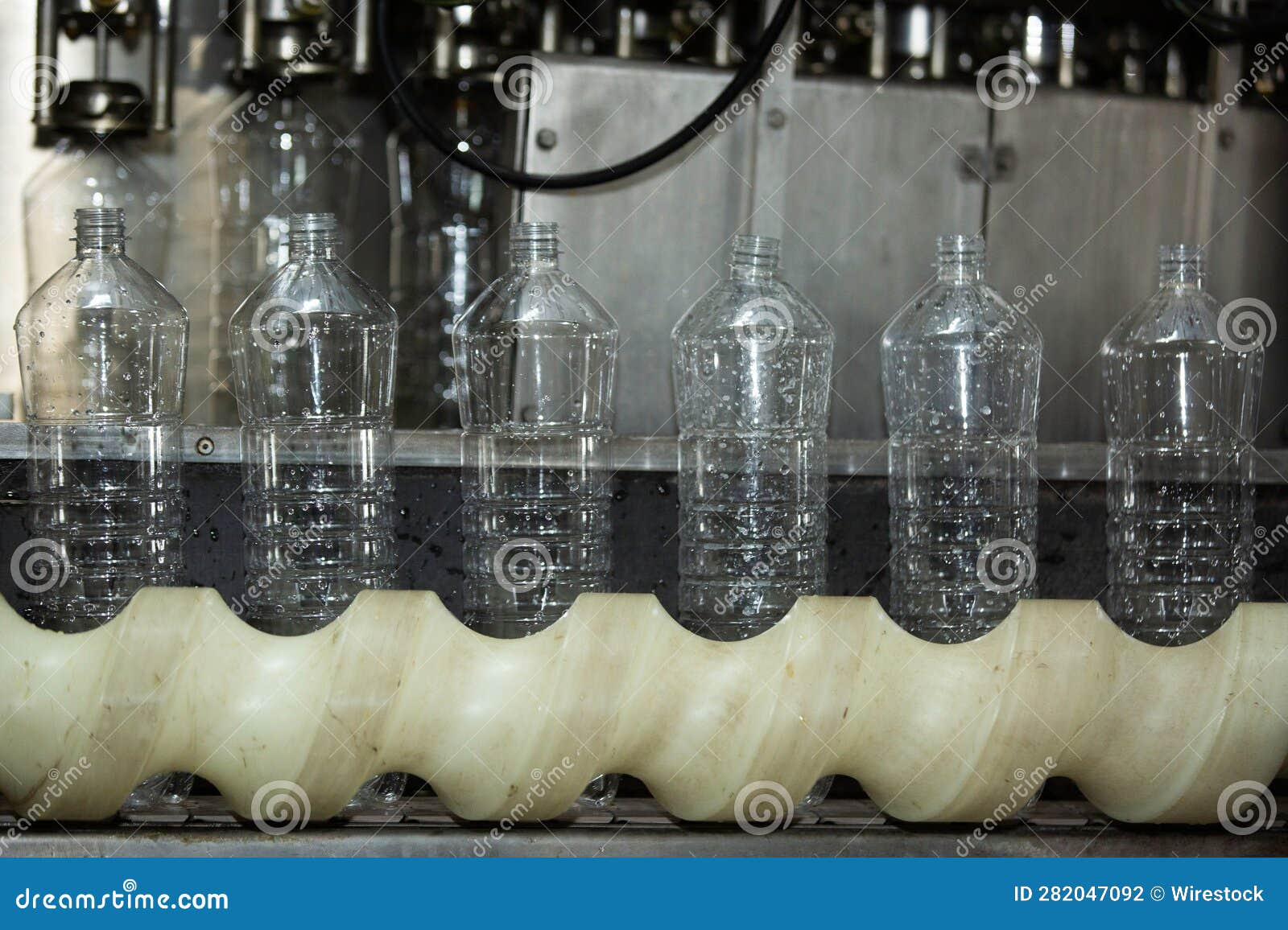 Row of Plastic Bottles Being Filled with Liquid Stock Photo - Image of ...