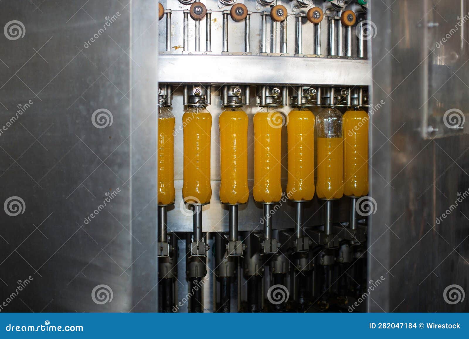 Row of Plastic Bottles Being Filled with Liquid Stock Photo - Image of ...